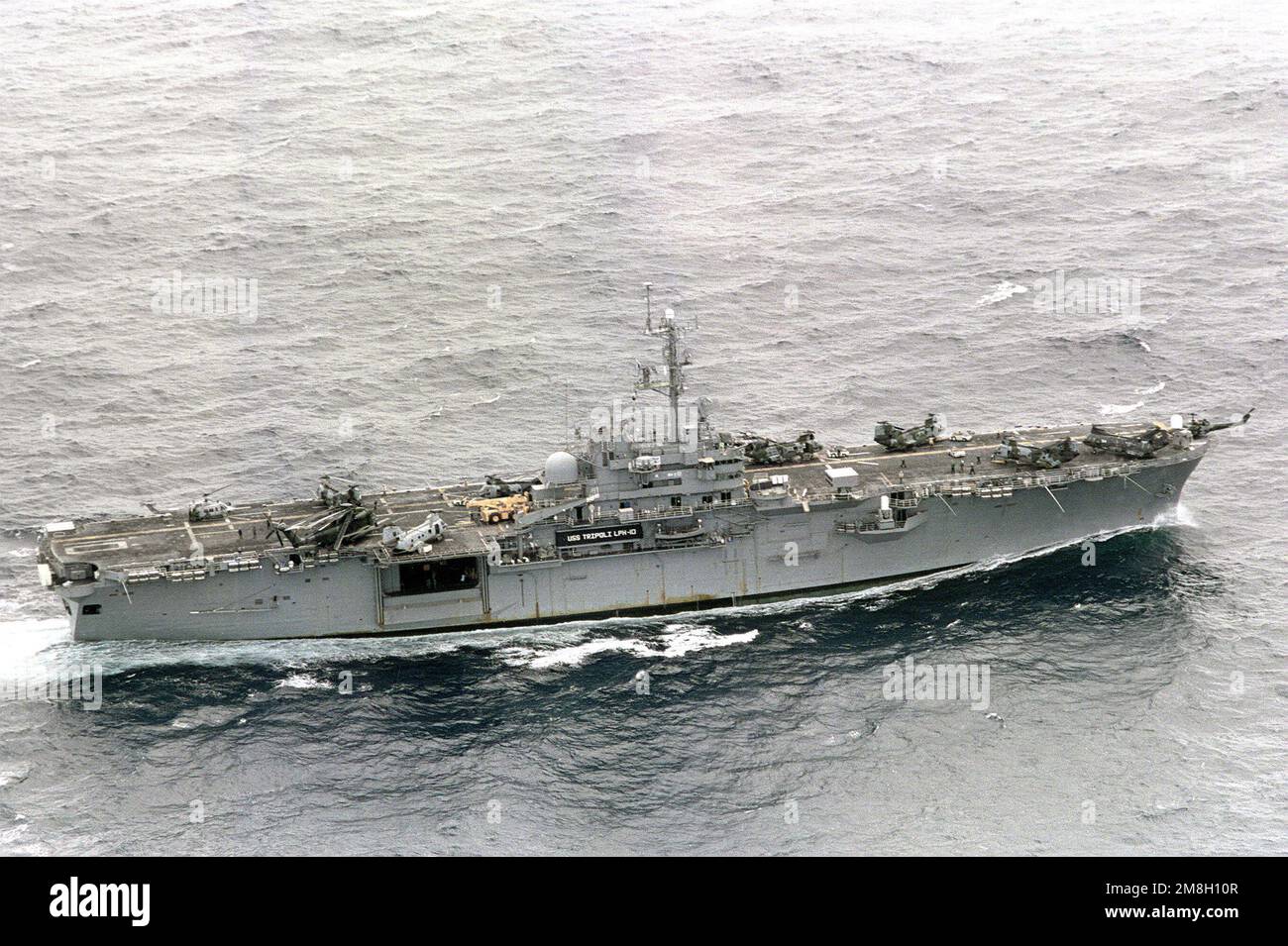 A starboard bow view of the amphibious assault ship USS TRIPOLI (LPH-10 ...