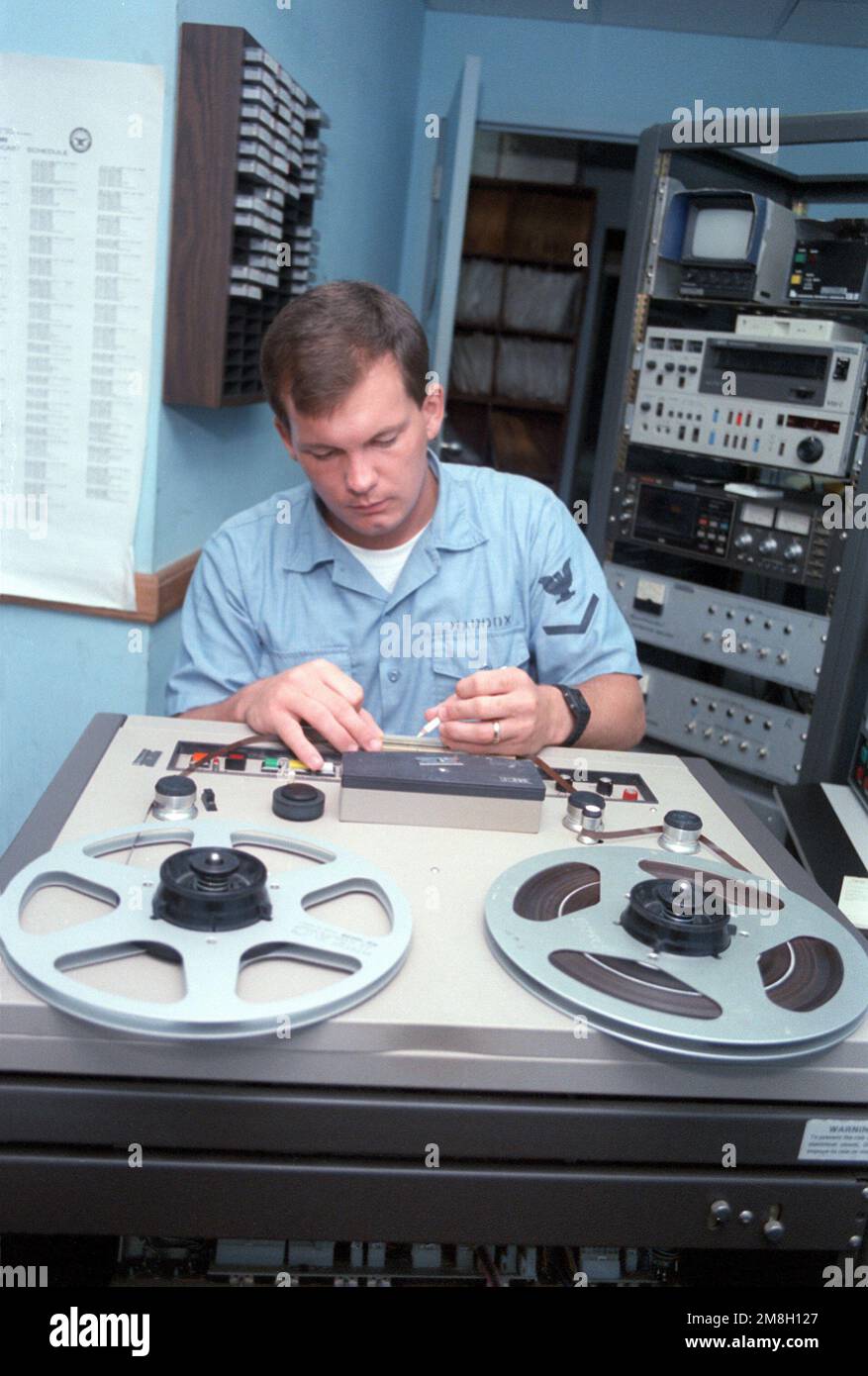 Journalist 3rd Class Chris Haddox edits audio tape in preparation for a ...