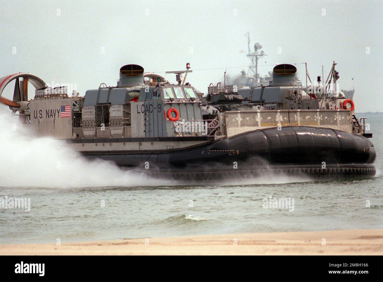 Air cushioned landing craft LCAC-9 comes ashore during an amphibious ...
