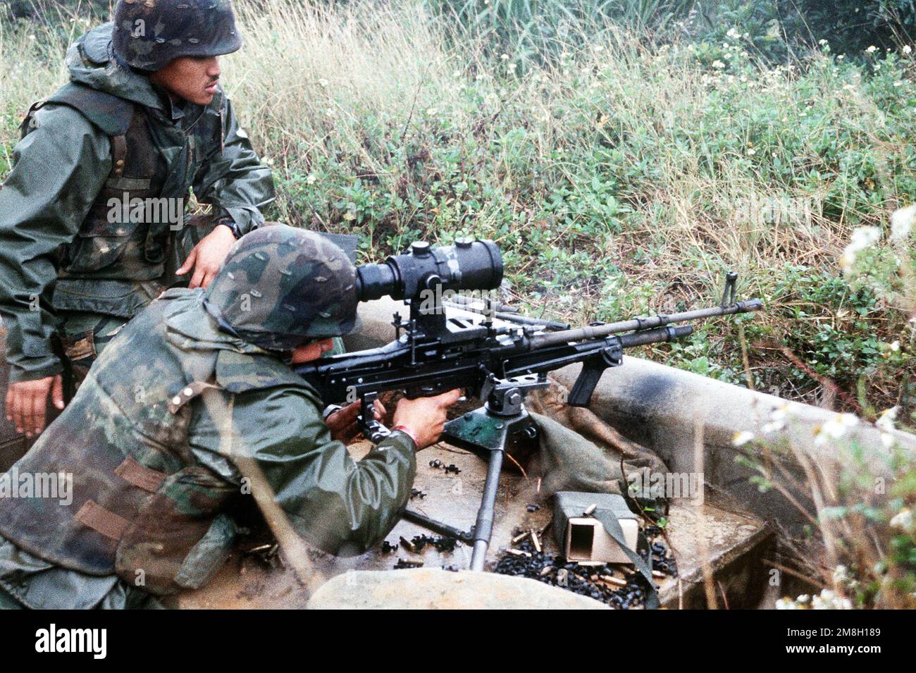 A 3rd Battalion, 6th Regiment, 3rd Marine Division, Marine fires an M ...
