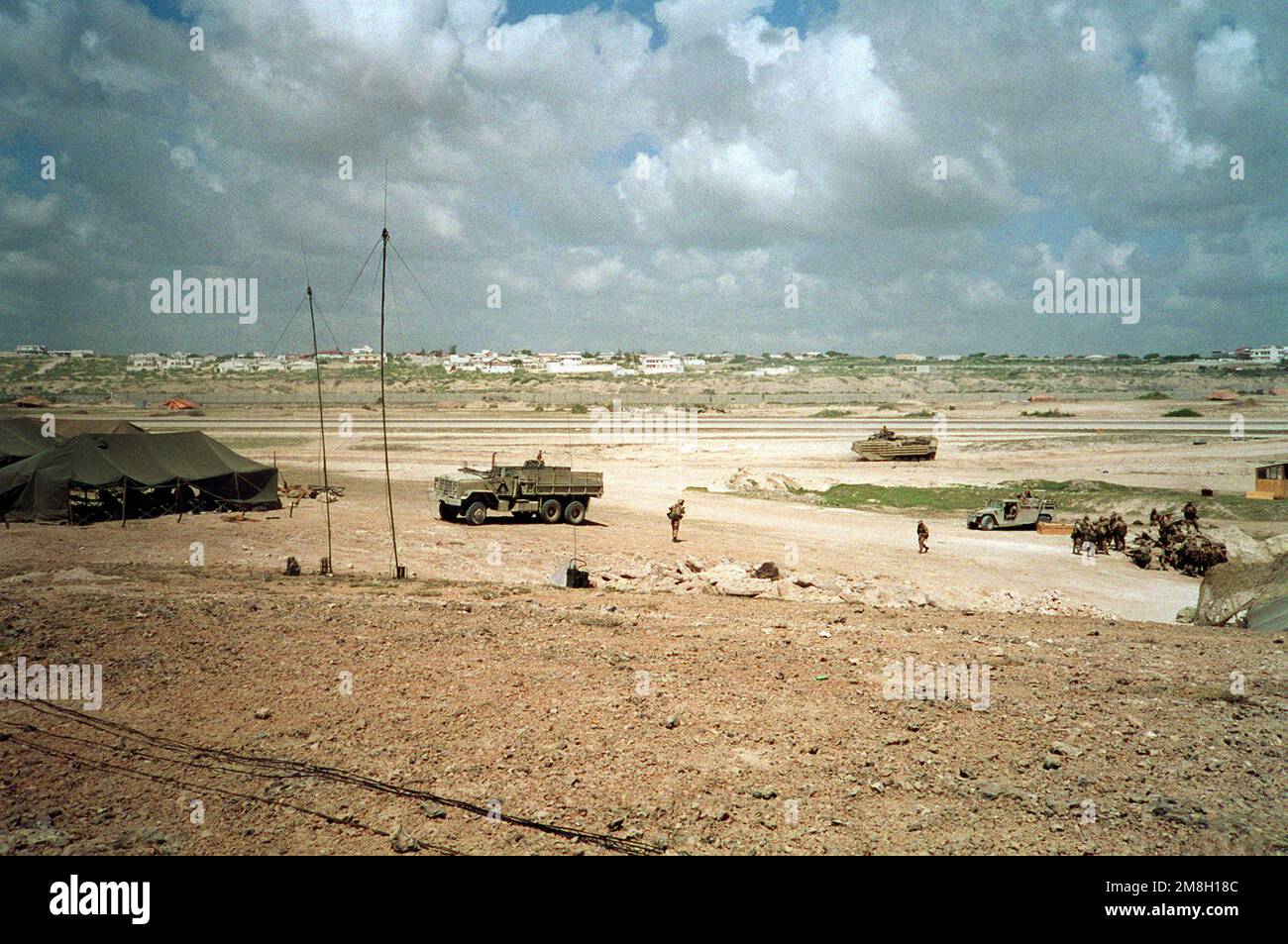A 5-ton cargo truck, foreground, and an AAVP-7A1 amphibious assault ...