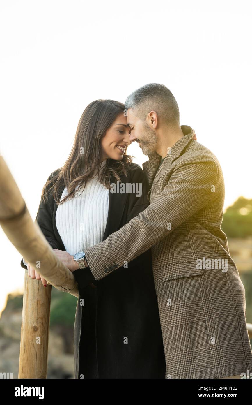 Romantic scene with a heterosexual couple looking each other and taking ...