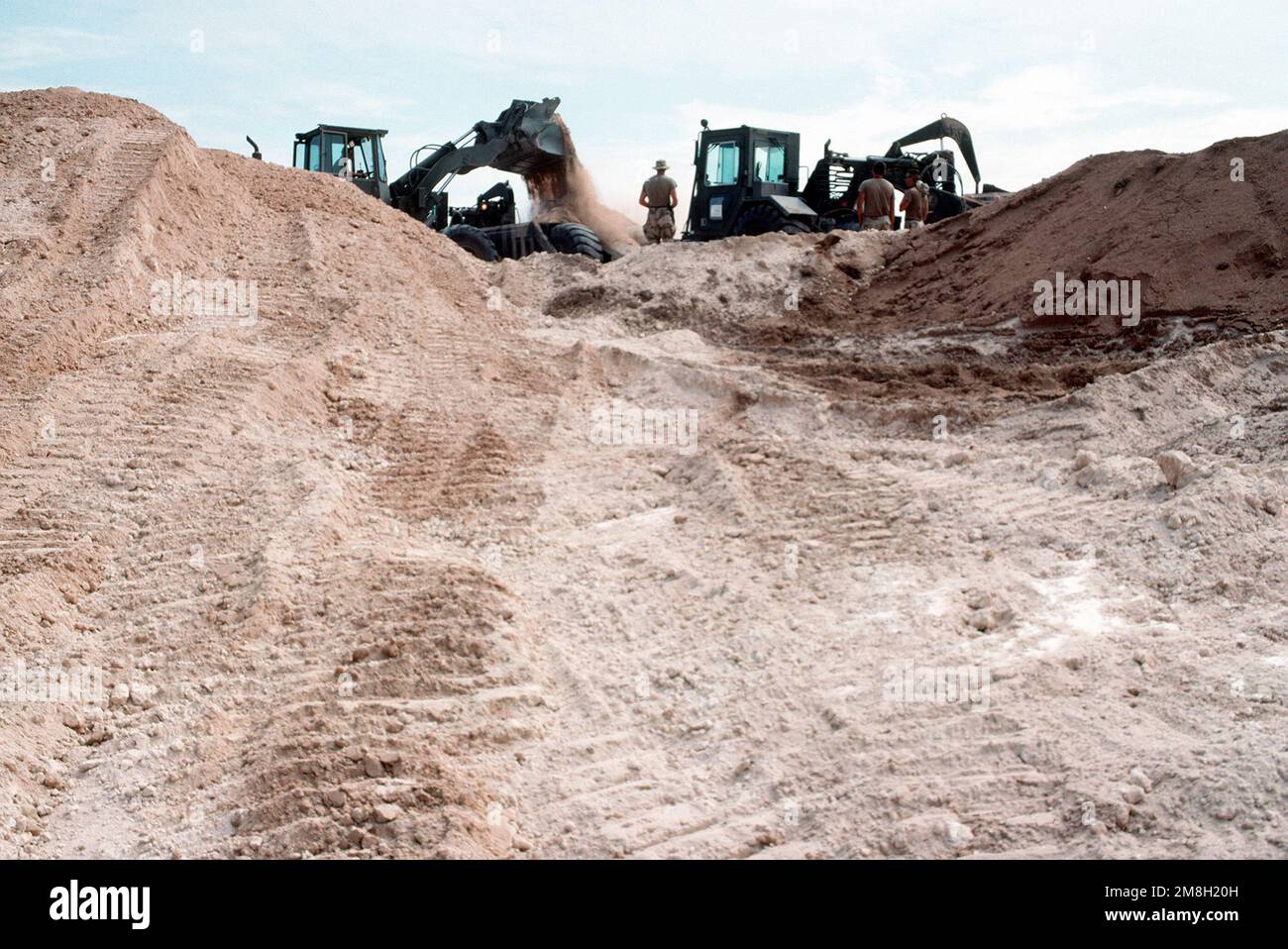 Members of Naval Mobile Construction Battalion 40 use heavy ...