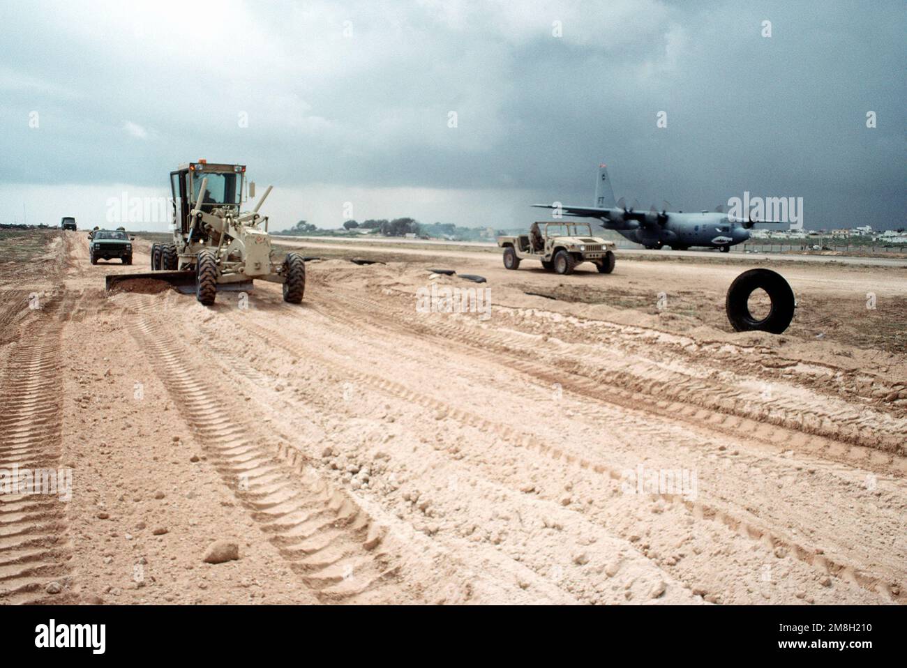 A member of Naval Mobile Construction Battalion 40 operates a motor ...
