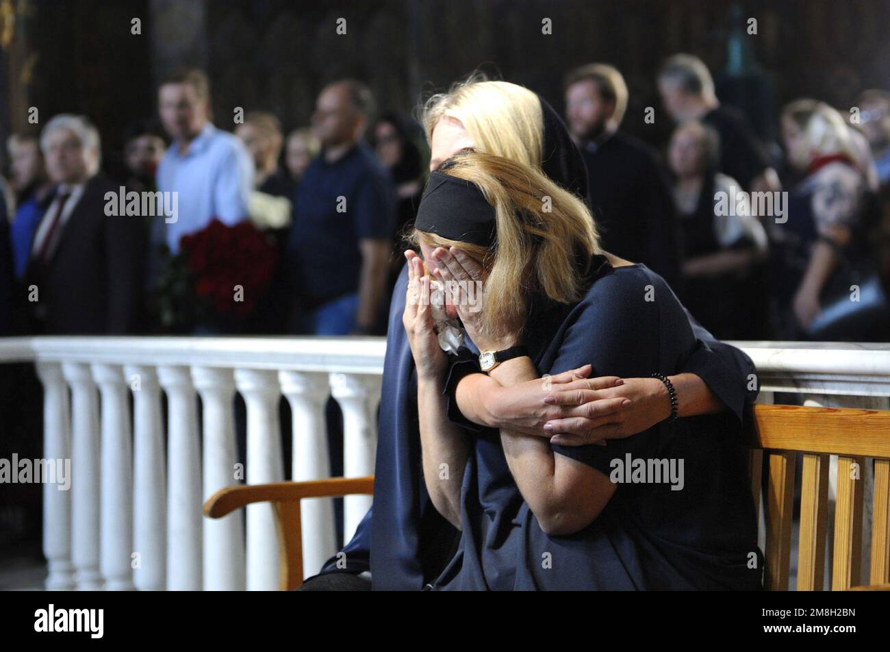 Burial service in a church: woman dressed in mourning clothes crying ...