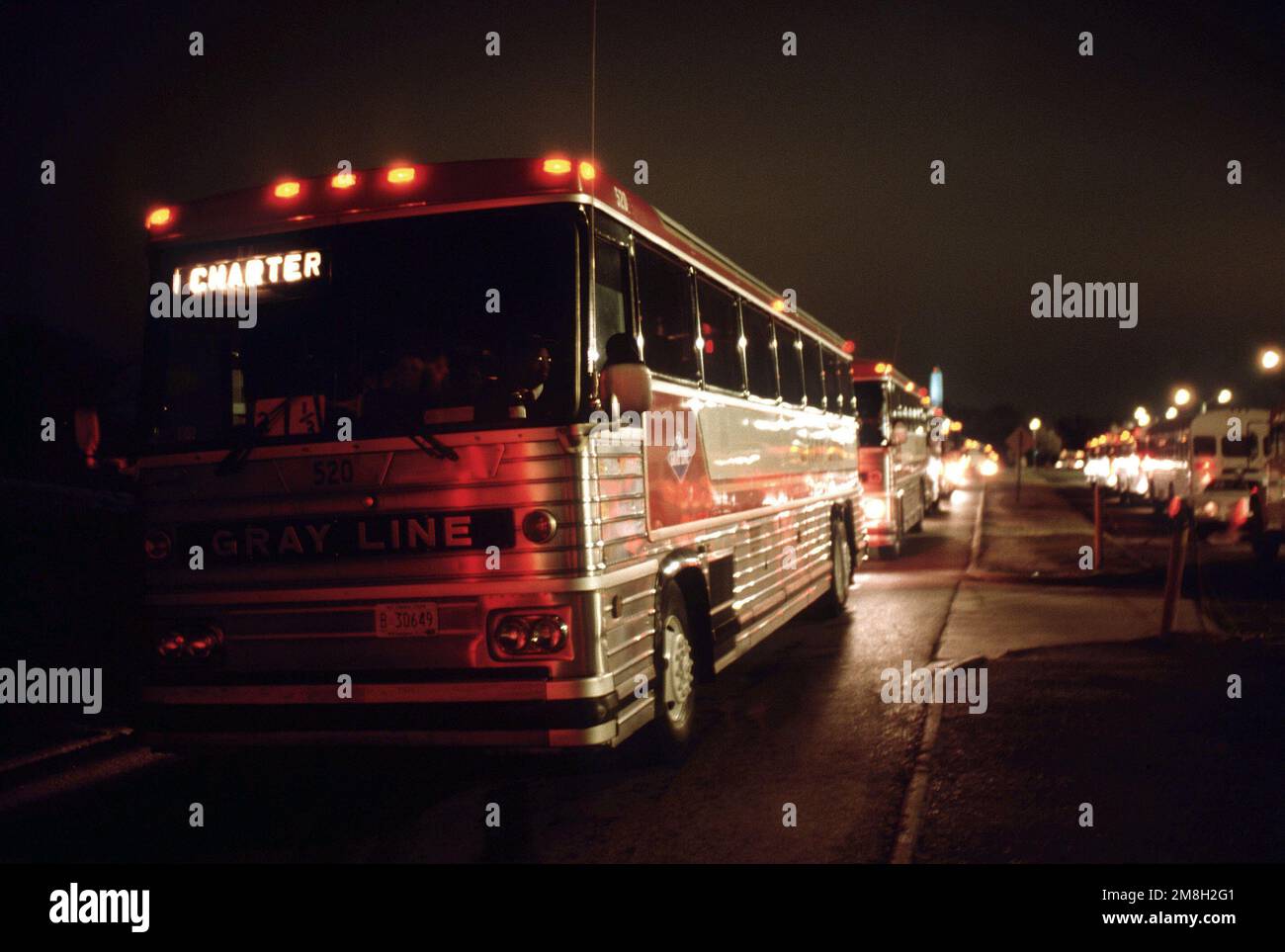 Practice Inaugural Parade. Buses loaded with military banks and parade ...