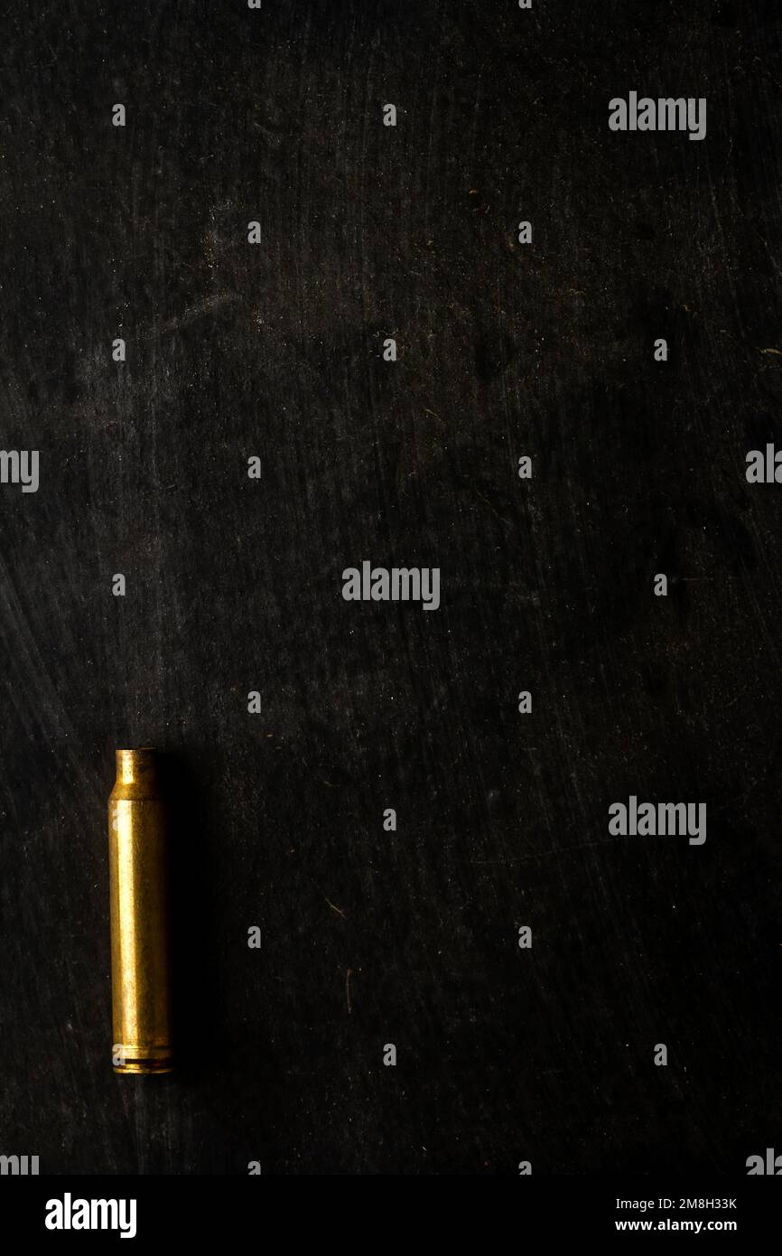 Empty rifle bullet cartridge lying on the black background Stock Photo ...