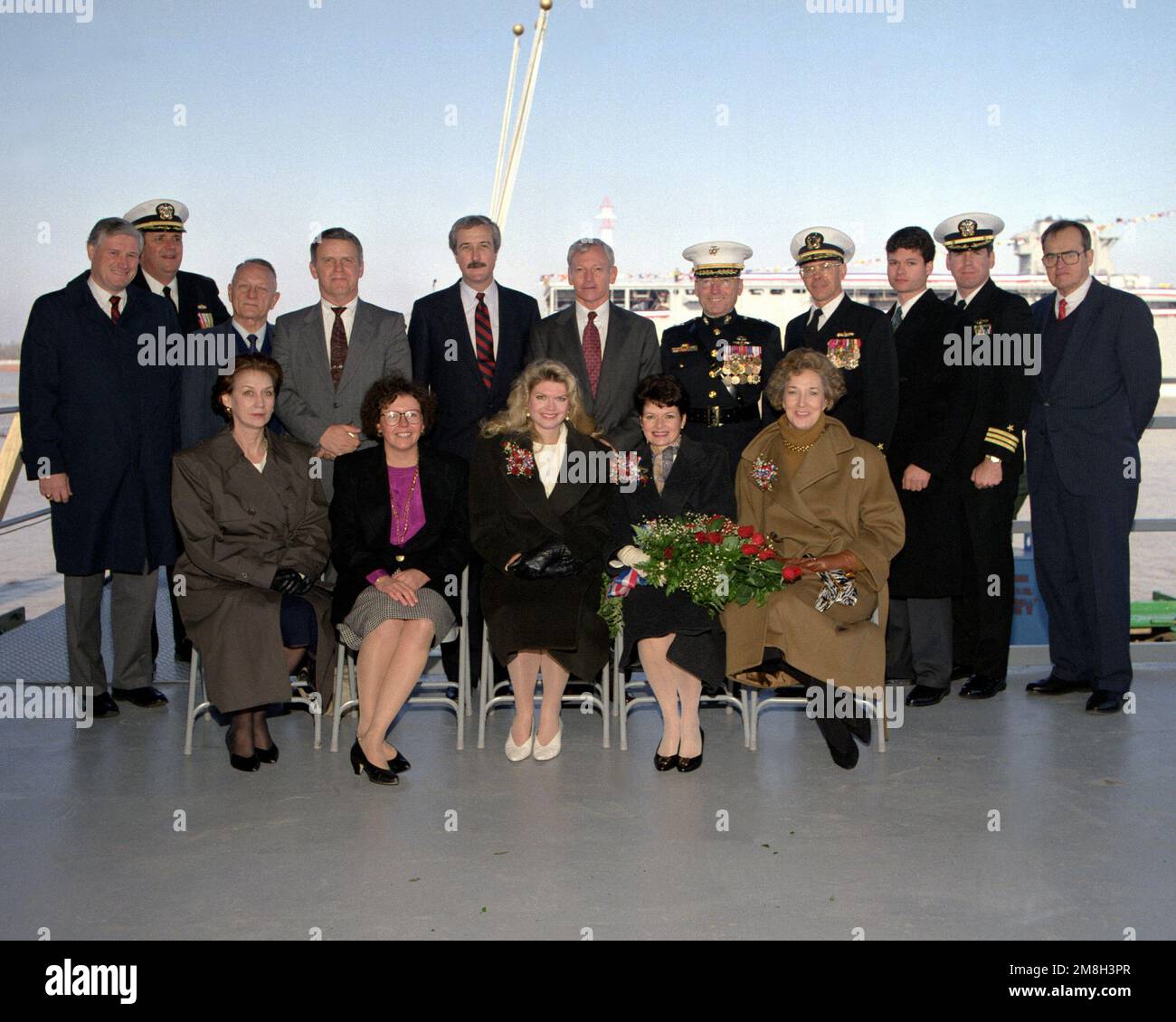 Navy and civilian dignitaries gather for a photograph following the ...