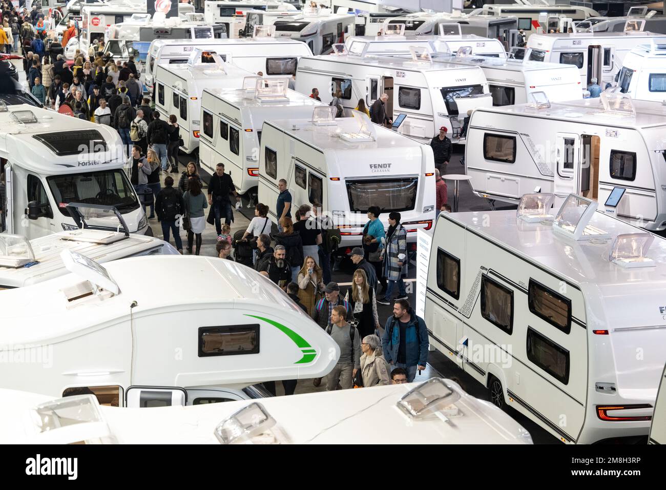 Stuttgart, Germany. 14th Jan, 2023. Visitors walk among motor homes and ...