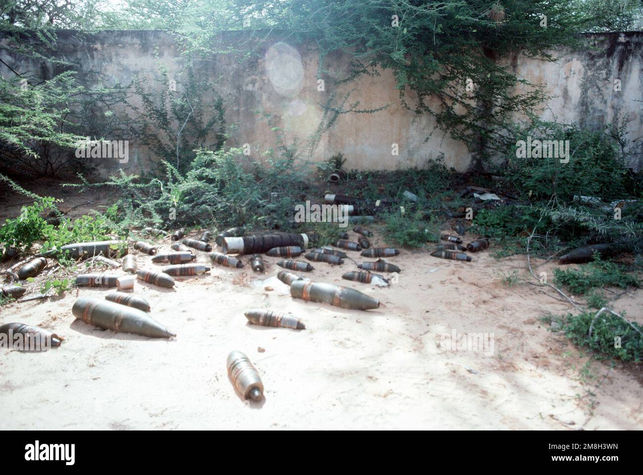 Artillery shells litter the ground outside a bunker near Afgoi. The ...