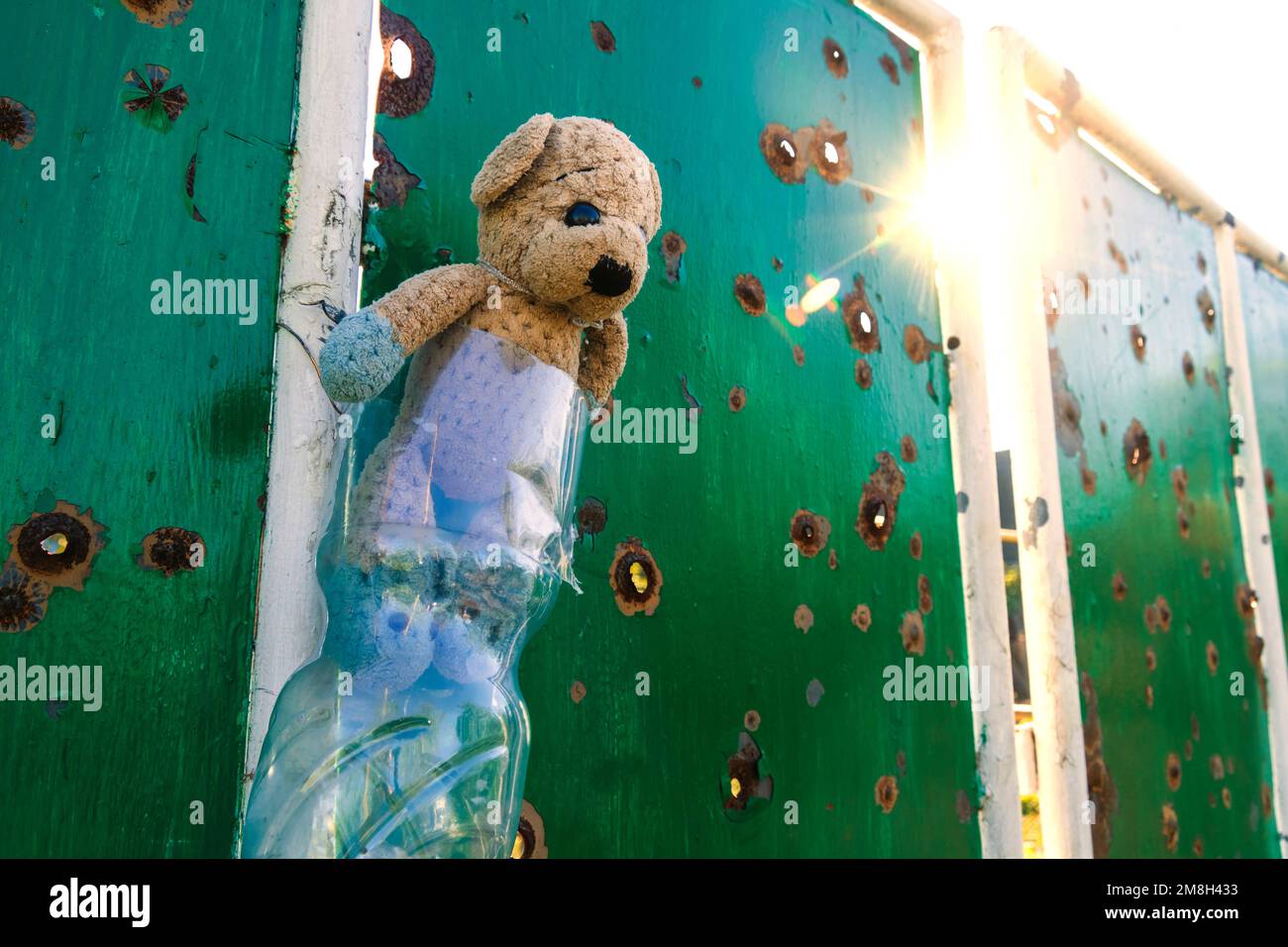 Teddy bear on fence hi-res stock photography and images - Alamy