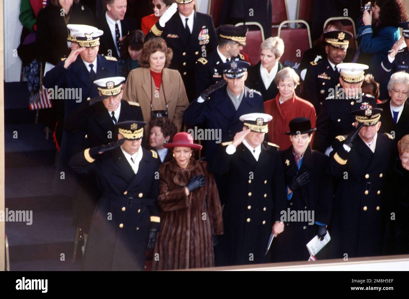 The military guests render honors to the flag as military units display the colors. Base ...