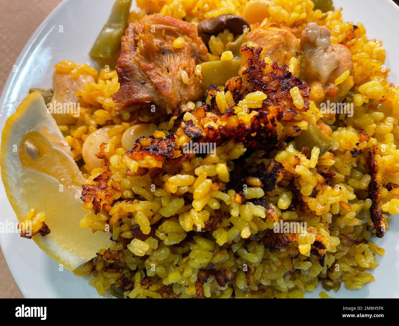 Rice cooked with vegetables called Paella Stock Photo - Alamy