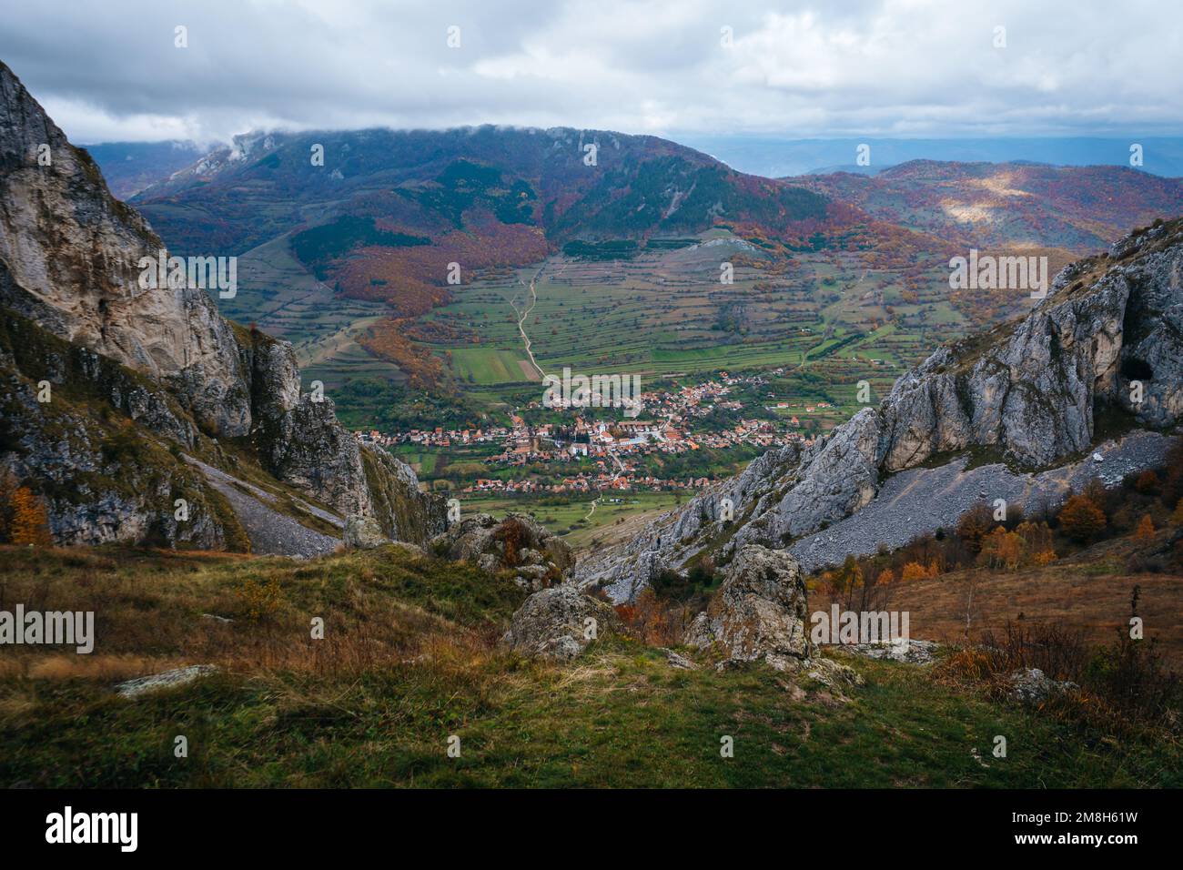 The small Rimetea village in Romania surrounded by the big mountains ...