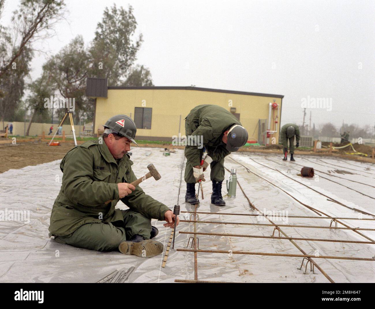 Builder 2nd Class Kaczinski, USNR, of Construction Battalion unit 406 ...