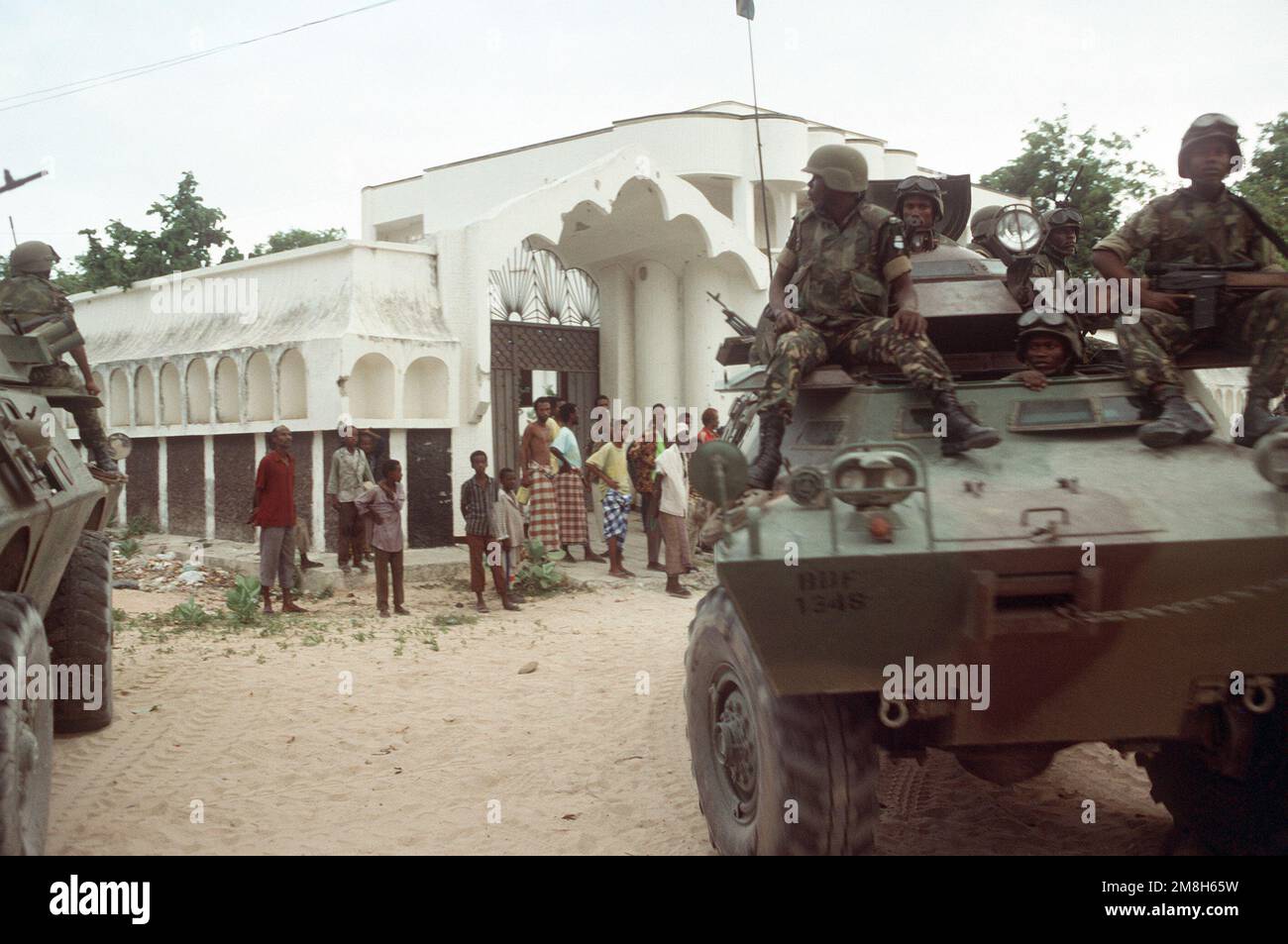 Members of a Botswani task force patrol through a village in a V-150 ...