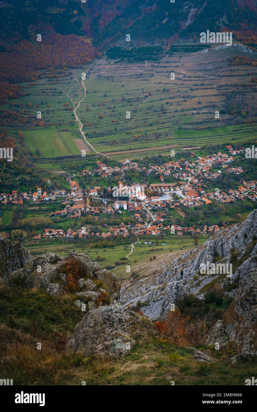 The small Rimetea village in the green field in Romania surrounded by ...