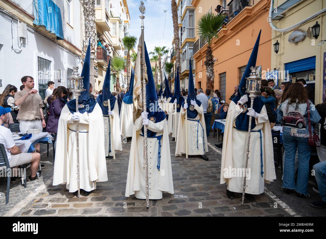 People in traditional dress weraing a capriote, or pointed hat in an ...