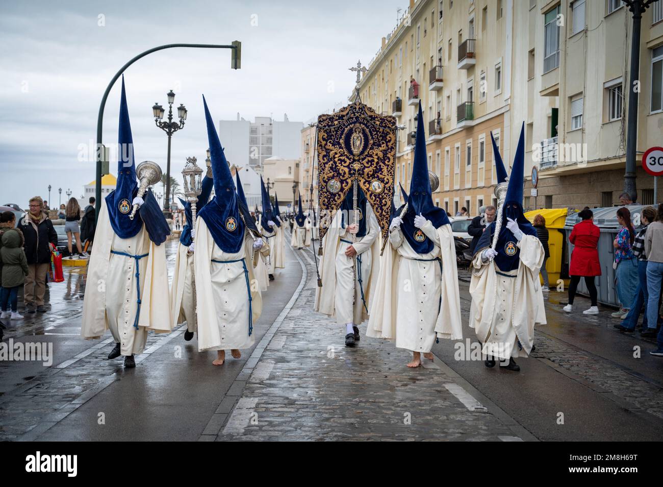 People in traditional dress weraing a capriote, or pointed hat in an ...