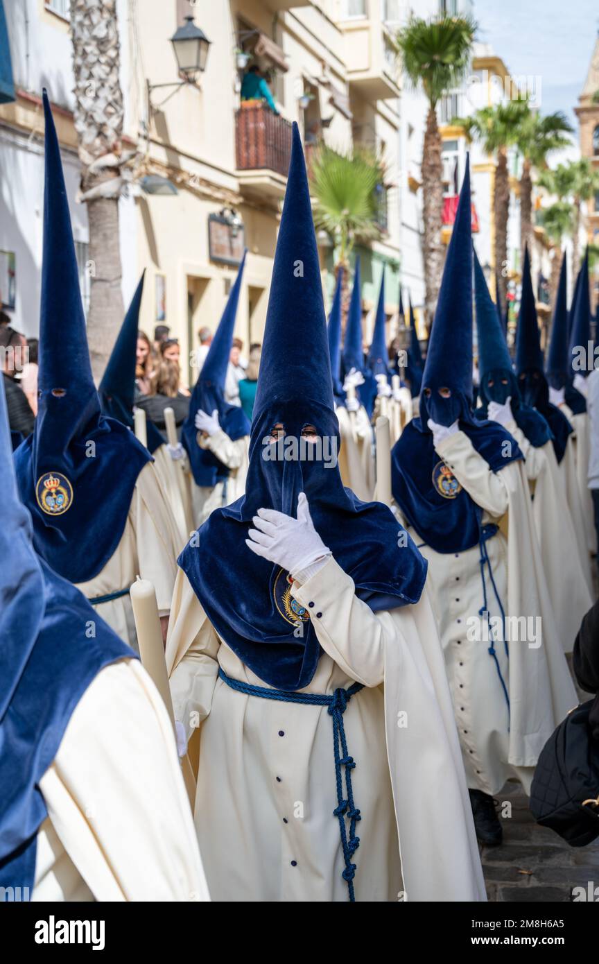 People in traditional dress weraing a capriote, or pointed hat in an ...