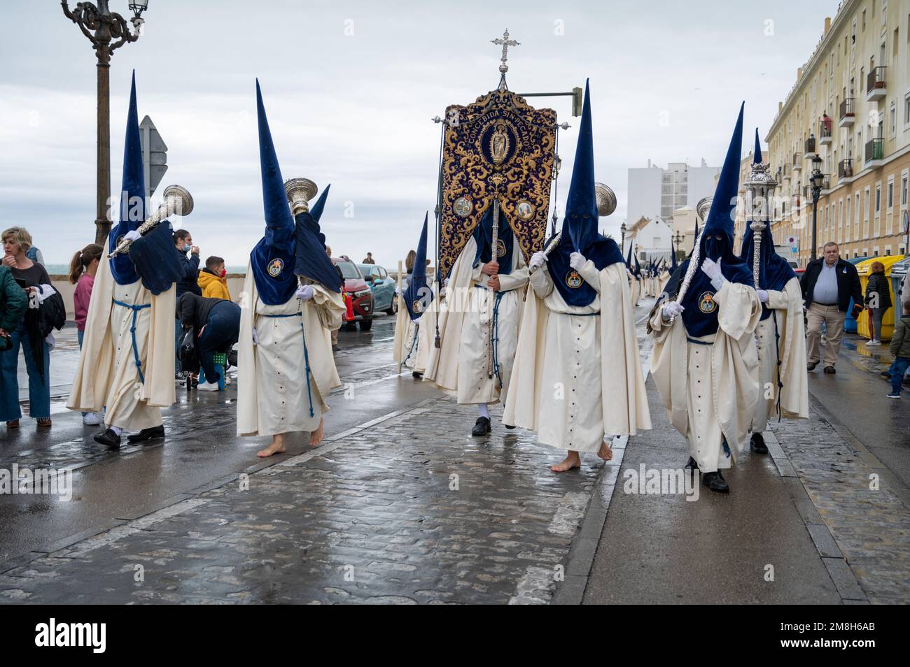People in traditional dress weraing a capriote, or pointed hat in an ...
