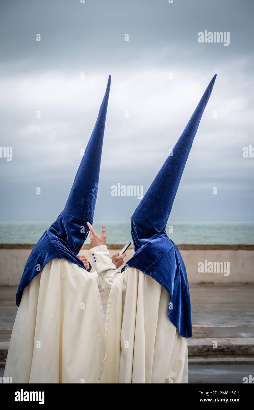 People in traditional dress weraing a capriote, or pointed hat in an ...