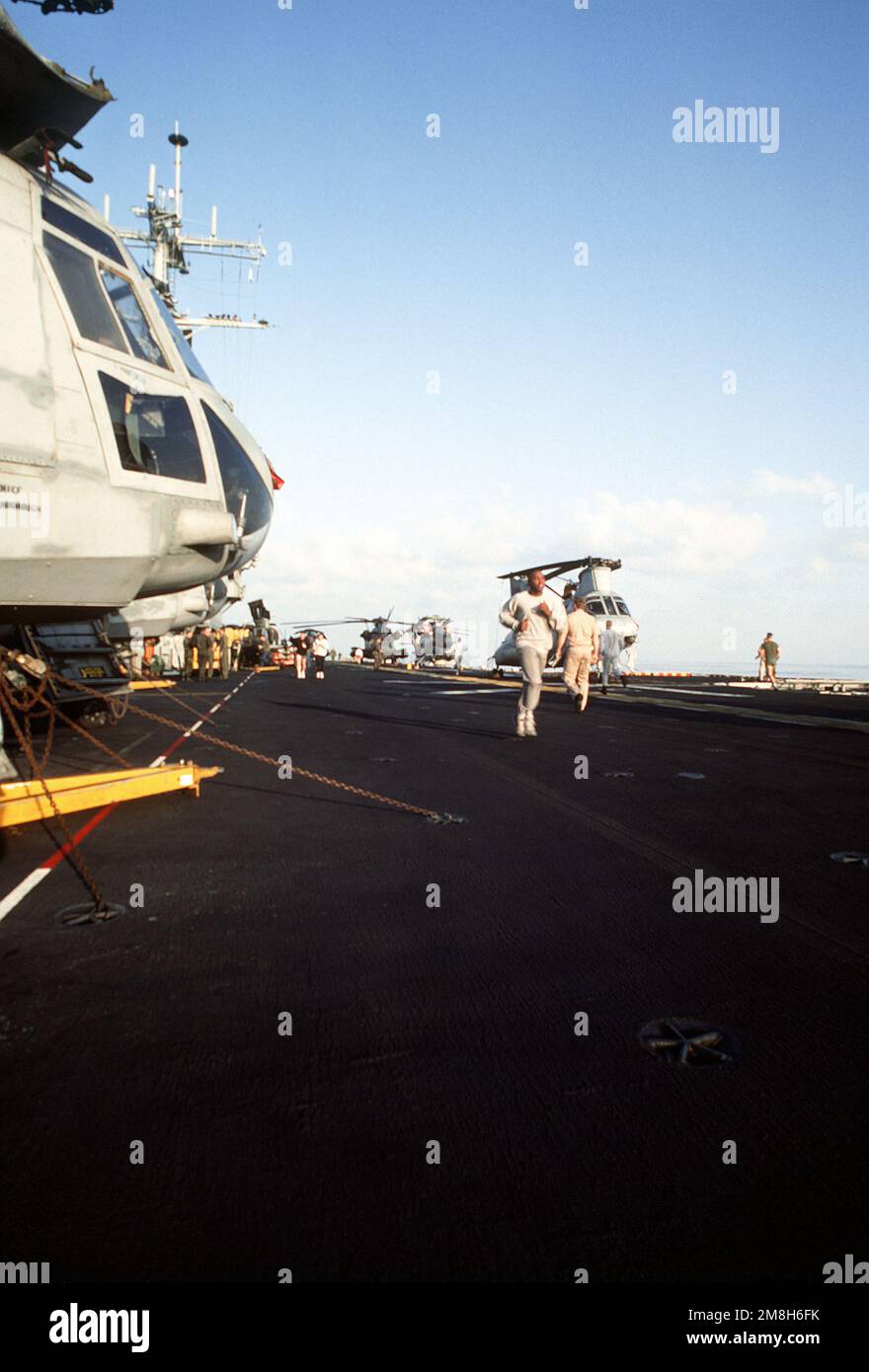 Members of the 22nd Marine Expeditionary Unit run on the flight deck of ...