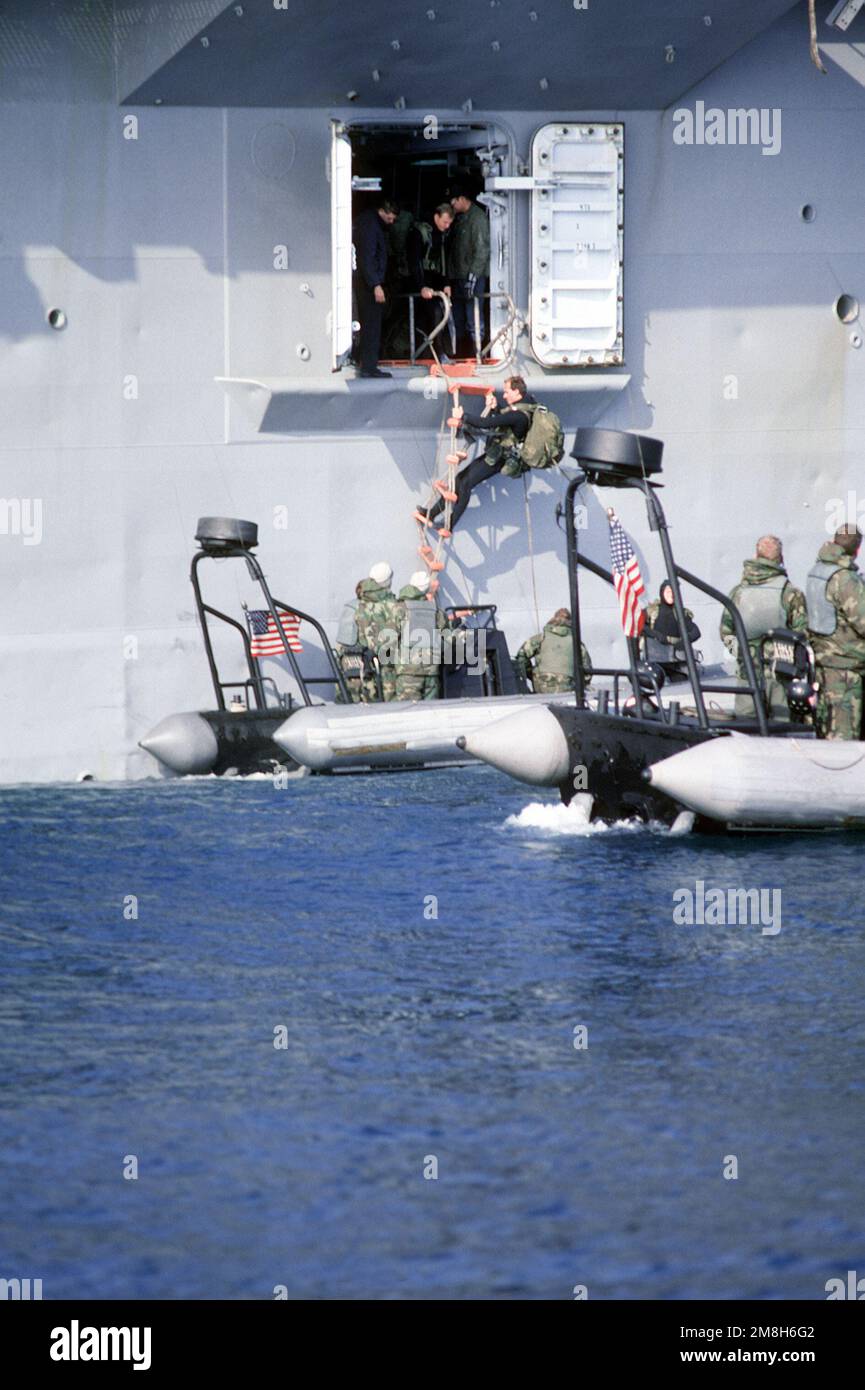 A member of Sea-Air-Land (SEAL) Team 8 boards a Special Boat Unit 20 ...