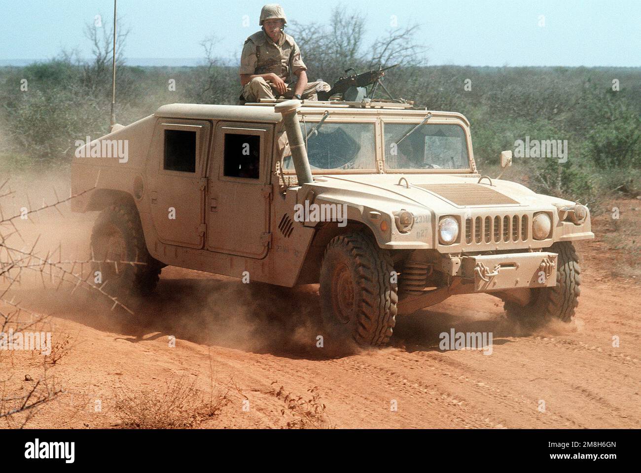 A Marine mans a 5.56mm M-249 squad automatic weapon (SAW) on the roof ...