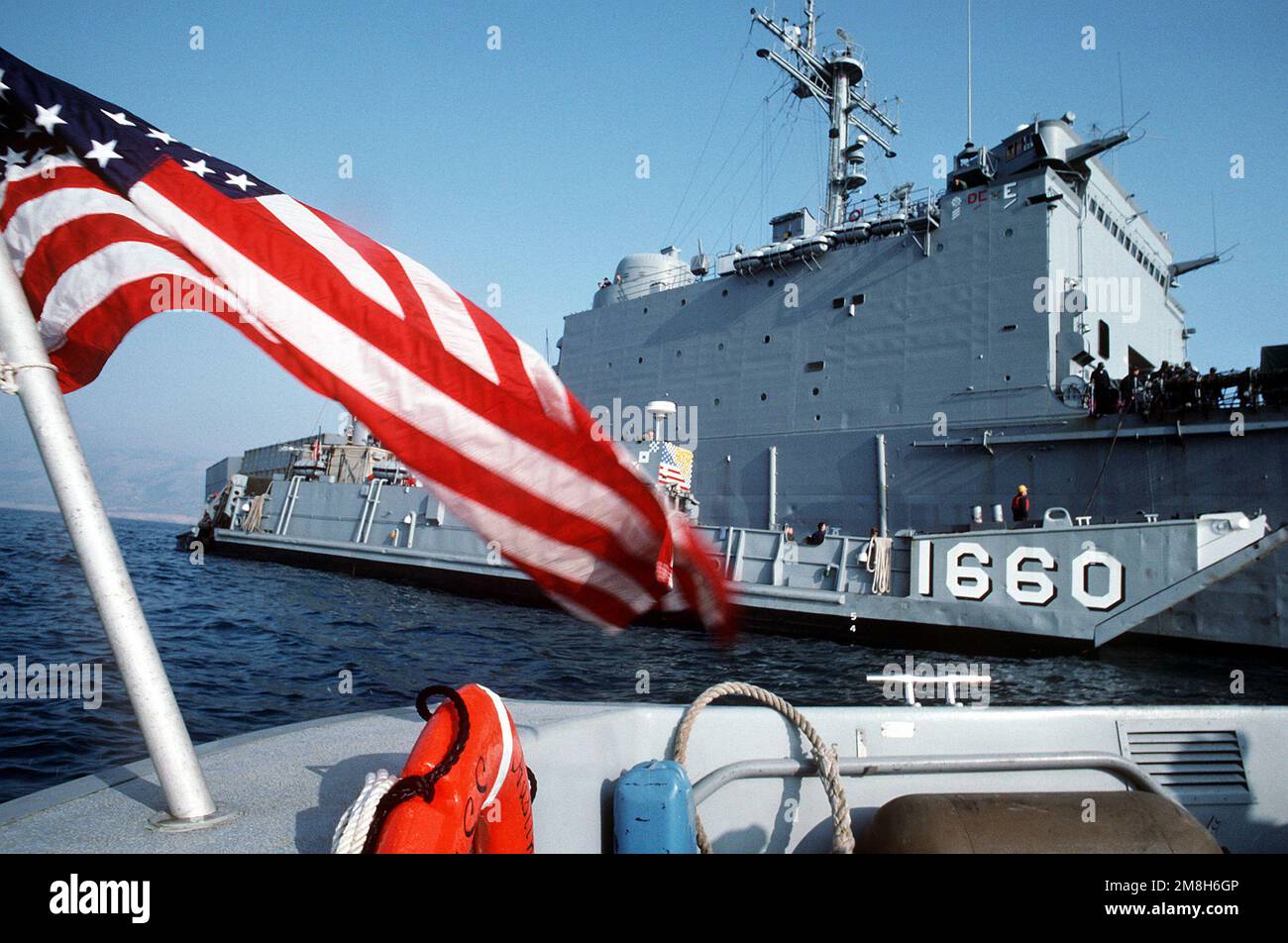 Crewmen on the deck of the tank landing ship USS SUMTER (LST-1181 ...