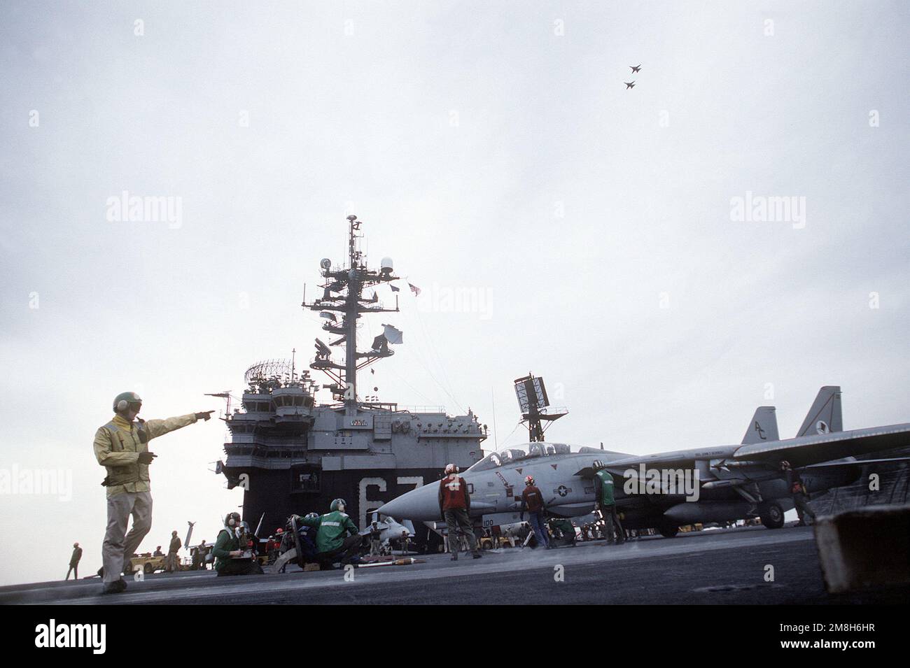 Members of a catapult crew prepare to launch a Fighter Squadron 14 (VF ...