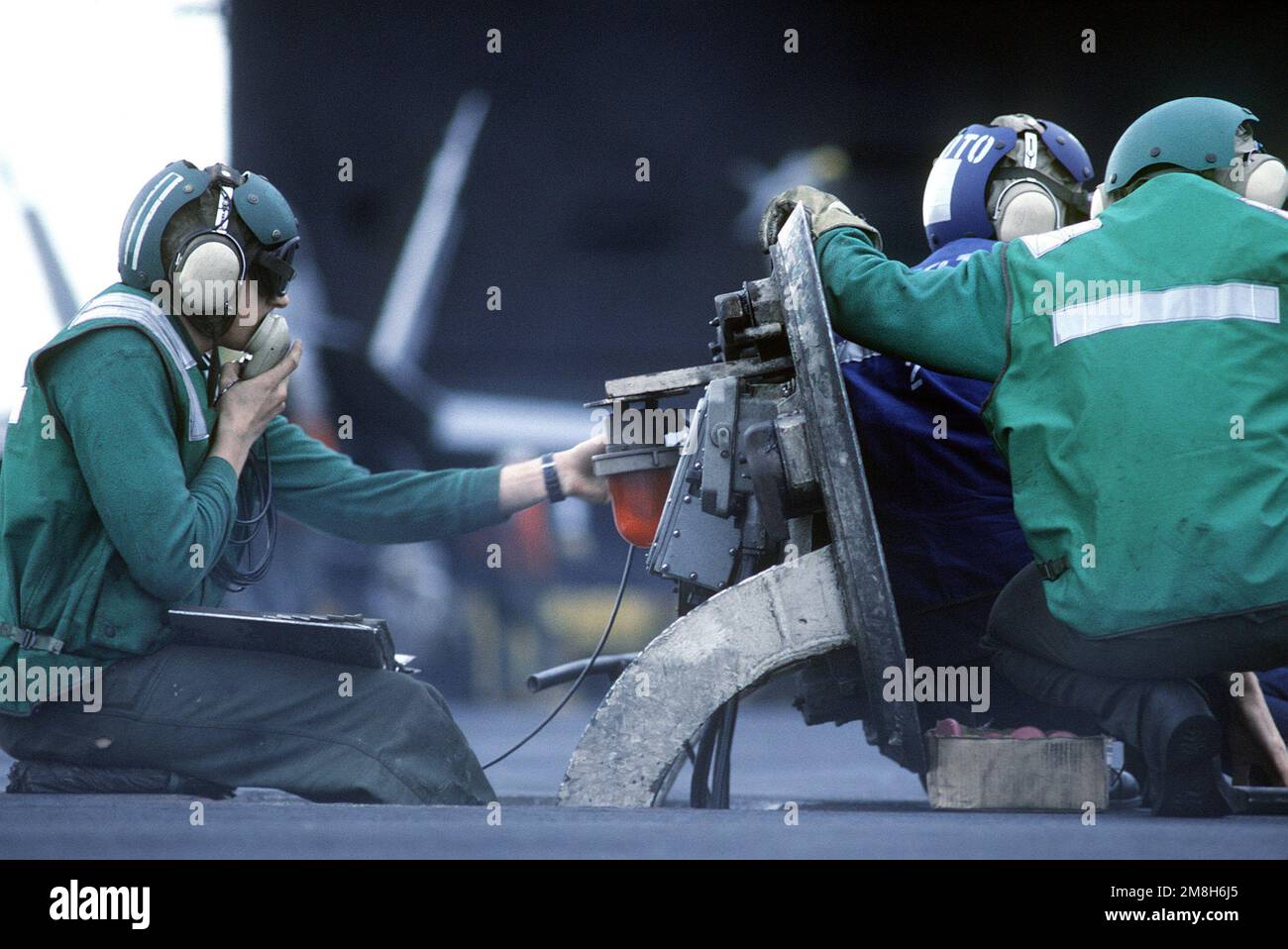 A catapult console operator checks his equipment during flight ...