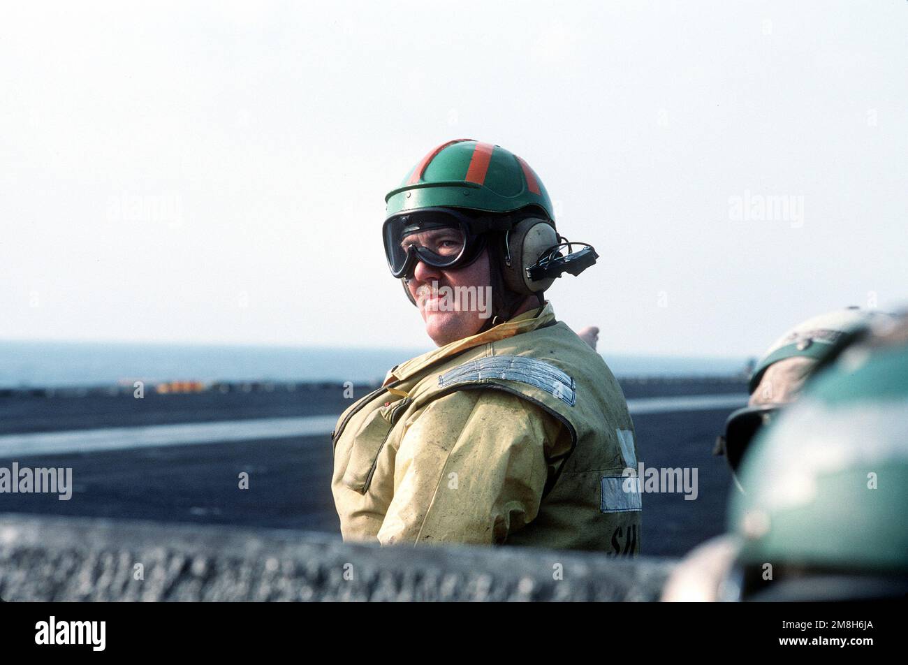 A catapult officer gives the launch signal to an aircraft about to be ...