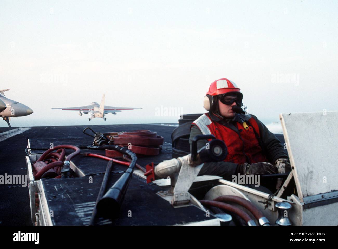 A member of the crash, salvage and rescue team mans a P-16 shipboard ...