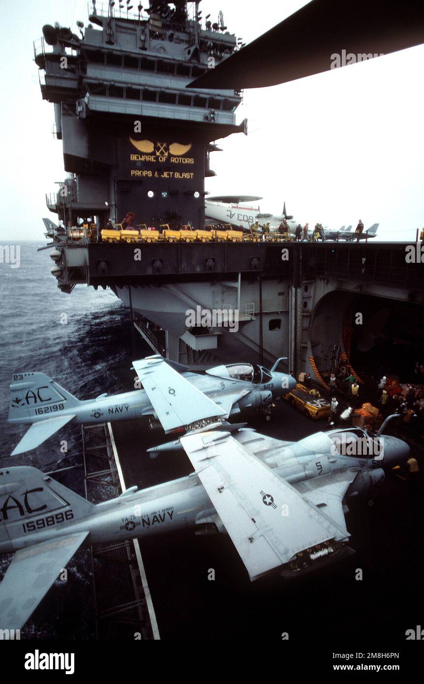 Flight deck crewmen prepare two Attack Squadron 75 (VA-75) A-6E ...