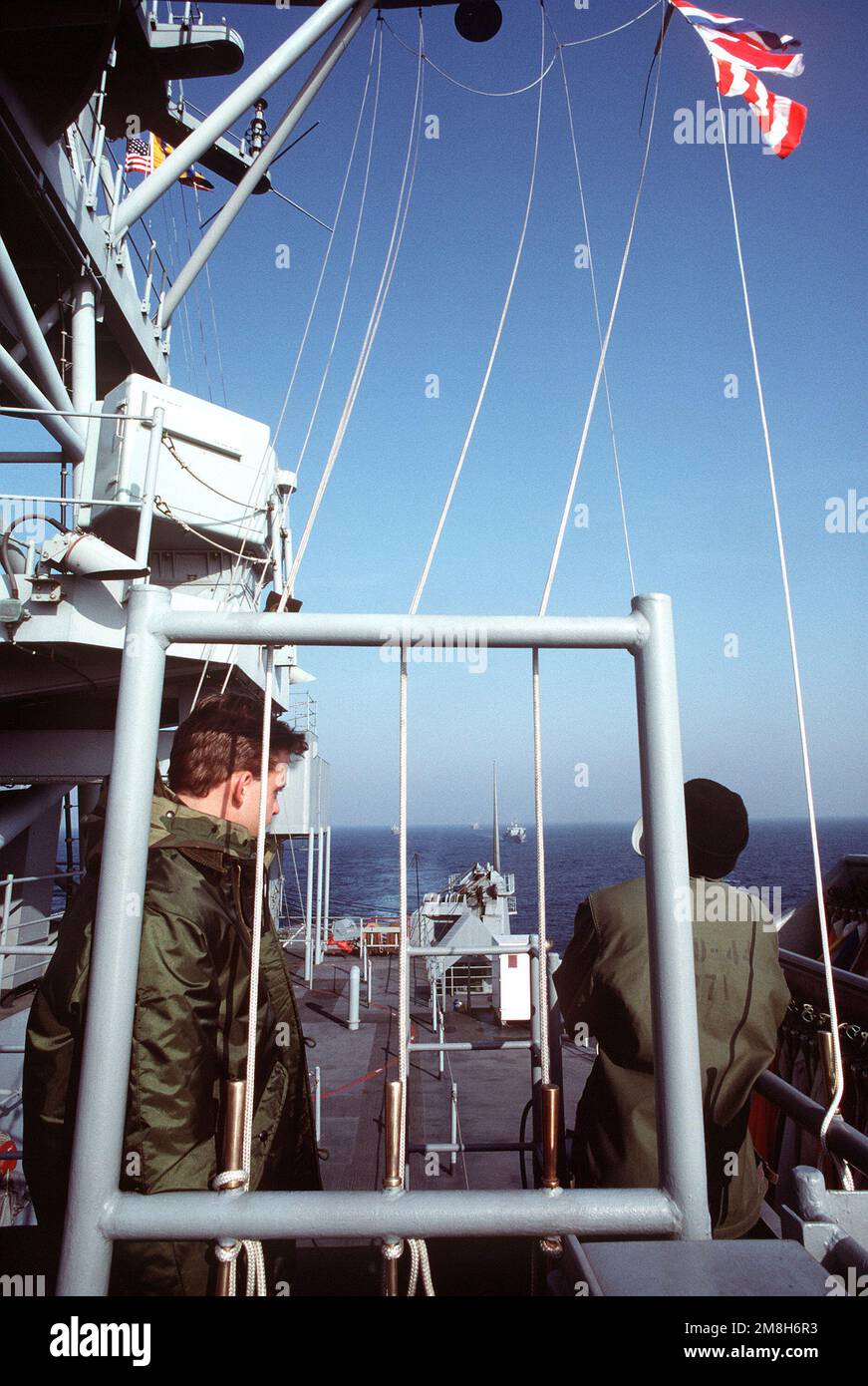 Signalmen hoist semaphore flags on the dock landing ship USS GUNSTON ...