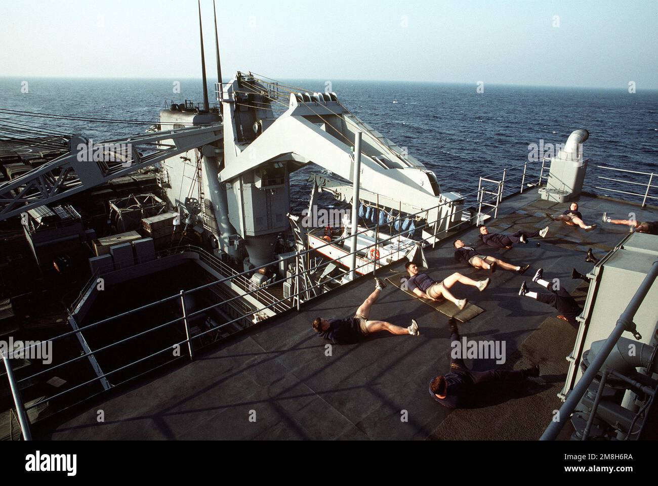 Marines perform leg lifts during morning physical training (PT) on the ...