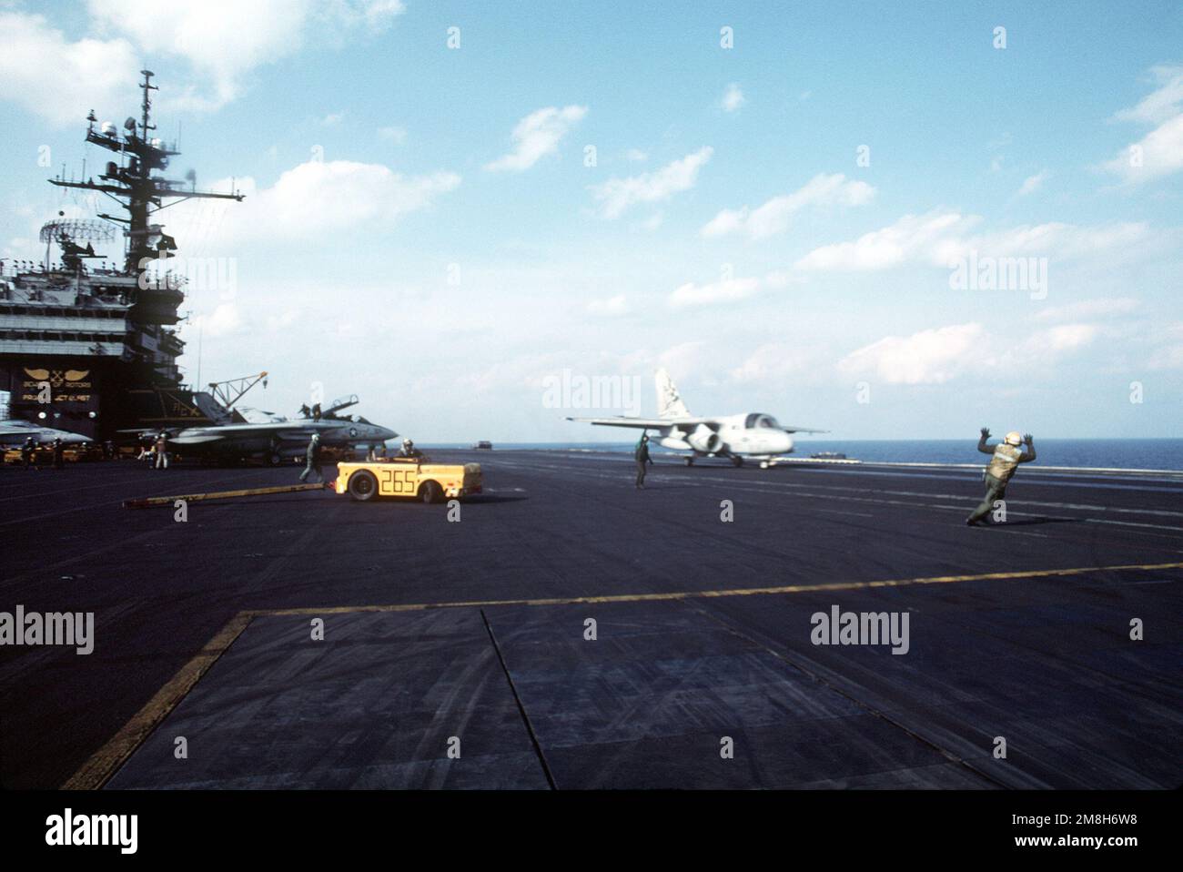 Flight deck crewmen signal to the pilot of an Air Anti-submarine ...