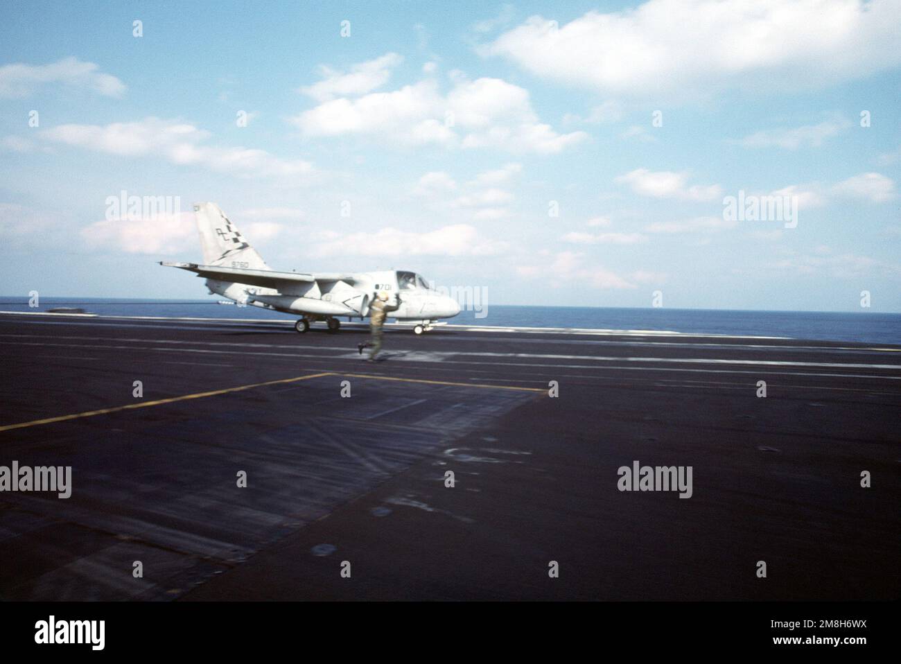 Flight deck crewmen signal to the pilot of an Air Anti-submarine ...