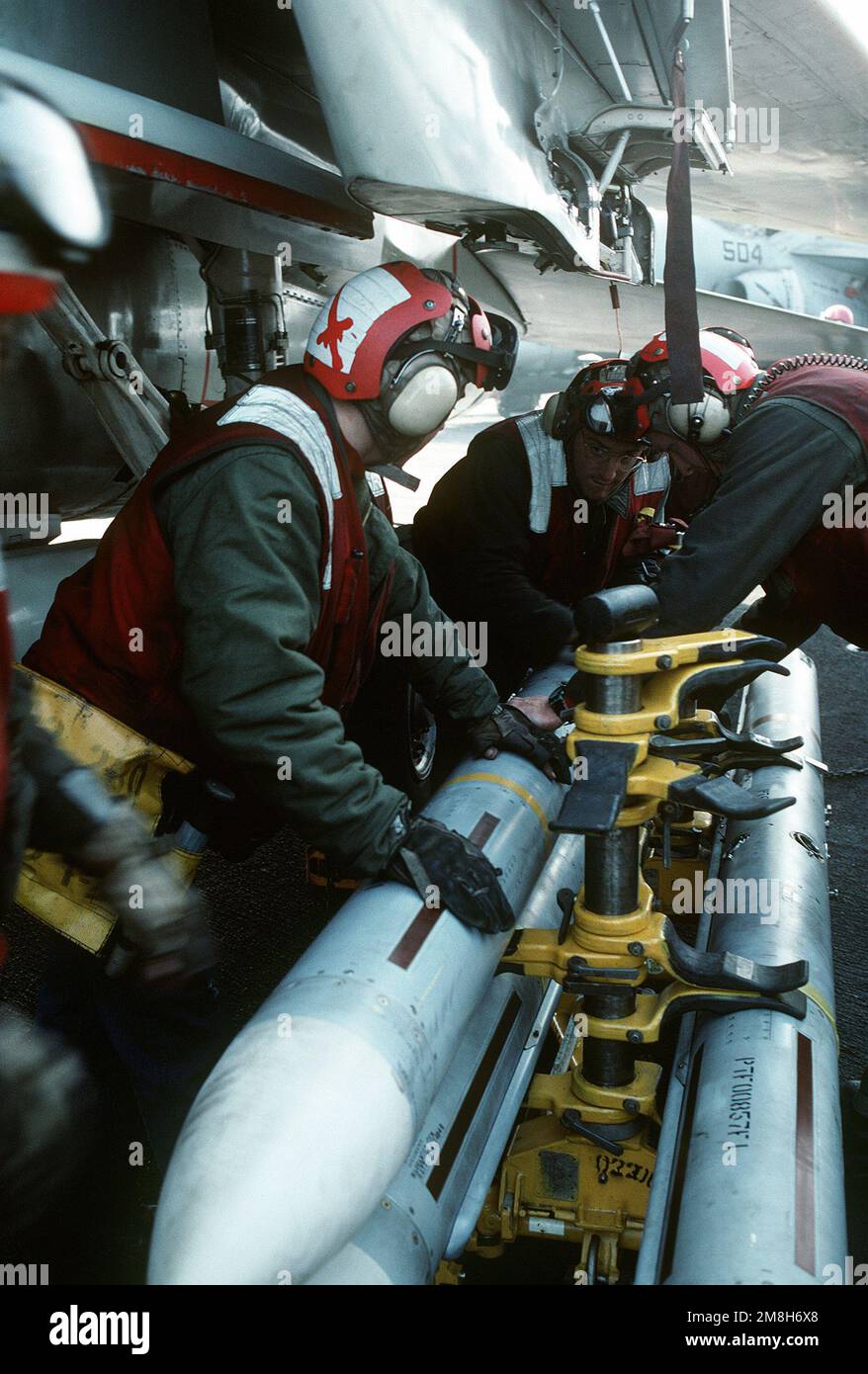 Aviation ordnancemen prepare to mount an AIM-7 Sparrow air-to-air ...