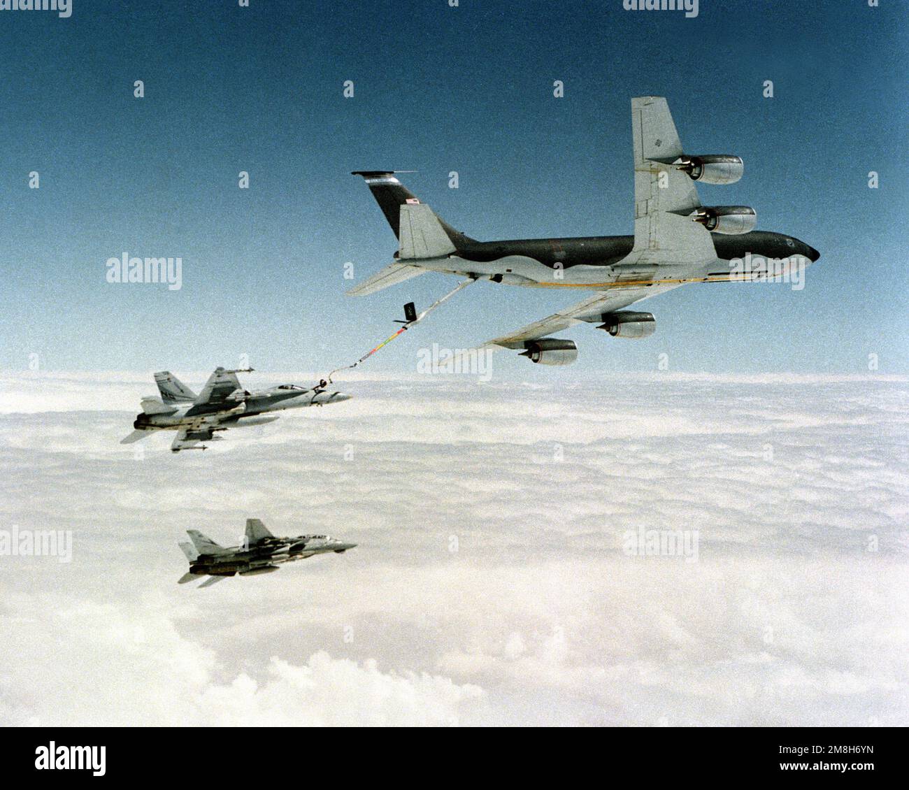 A Strike Fighter Squadron 147 (VFA-147) F/A-18C Hornet aircraft refuels ...