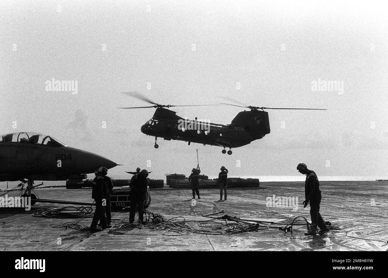 Crew members sort hoisting slings on the flight deck of the nuclear ...