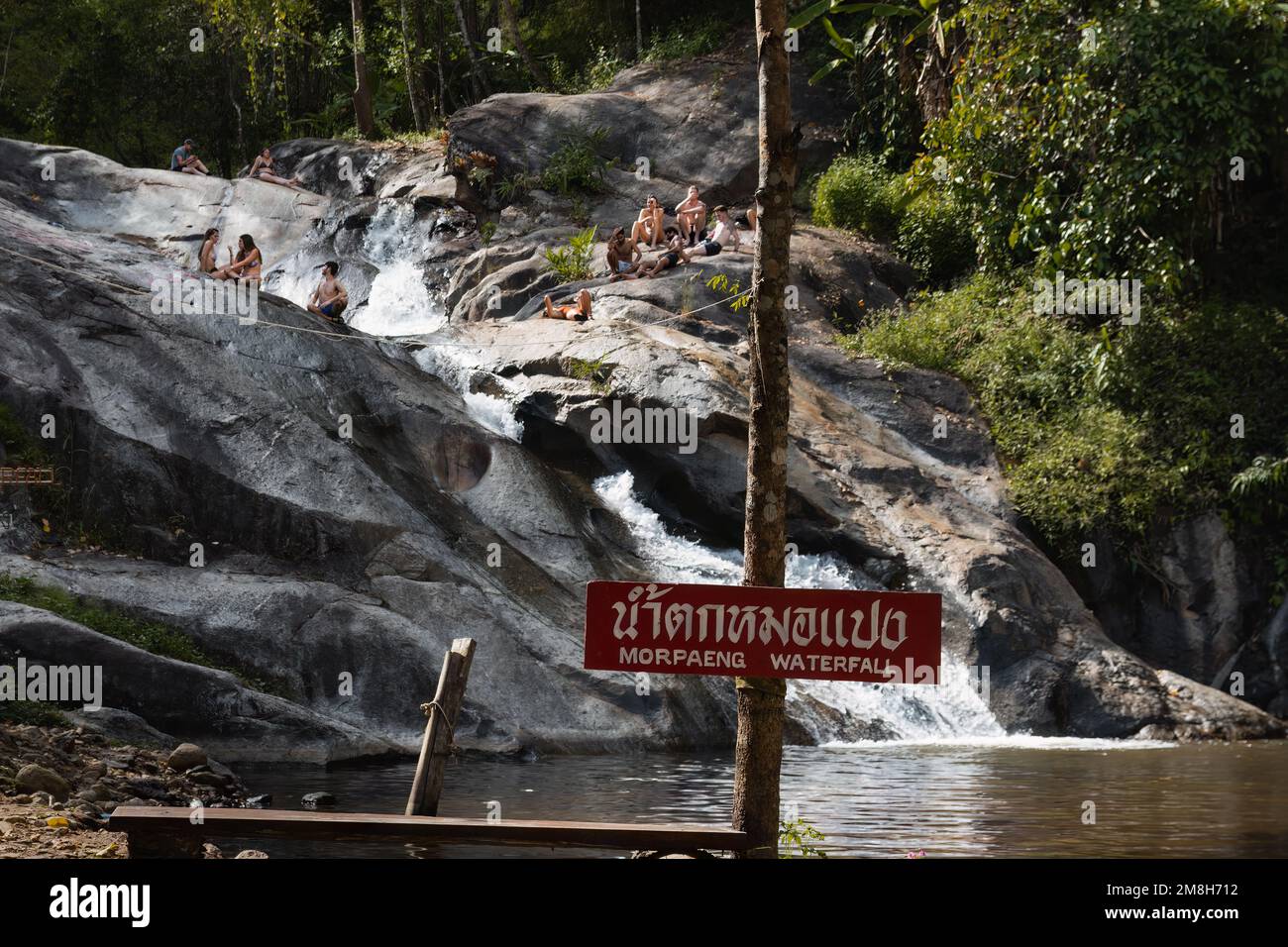 Pai, Thailand. November 25, 2022. Mo Paeng Waterfall sign with tourists ...