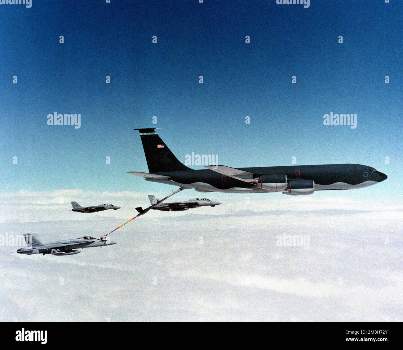 A Strike Fighter Squadron 147 (VFA-147) F/A-18C Hornet aircraft refuels ...