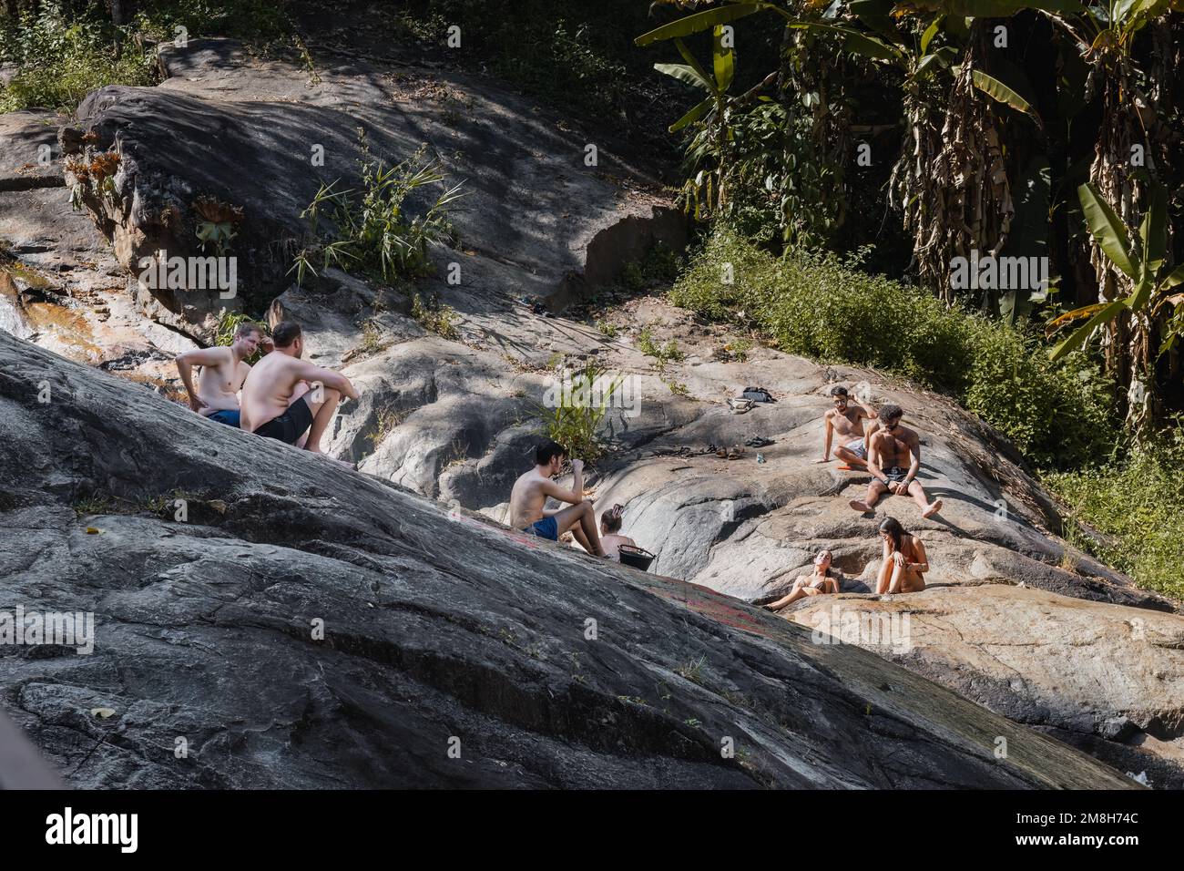 Pai, Thailand. November 25, 2022. Tourists sitting on the rocks of Mo ...