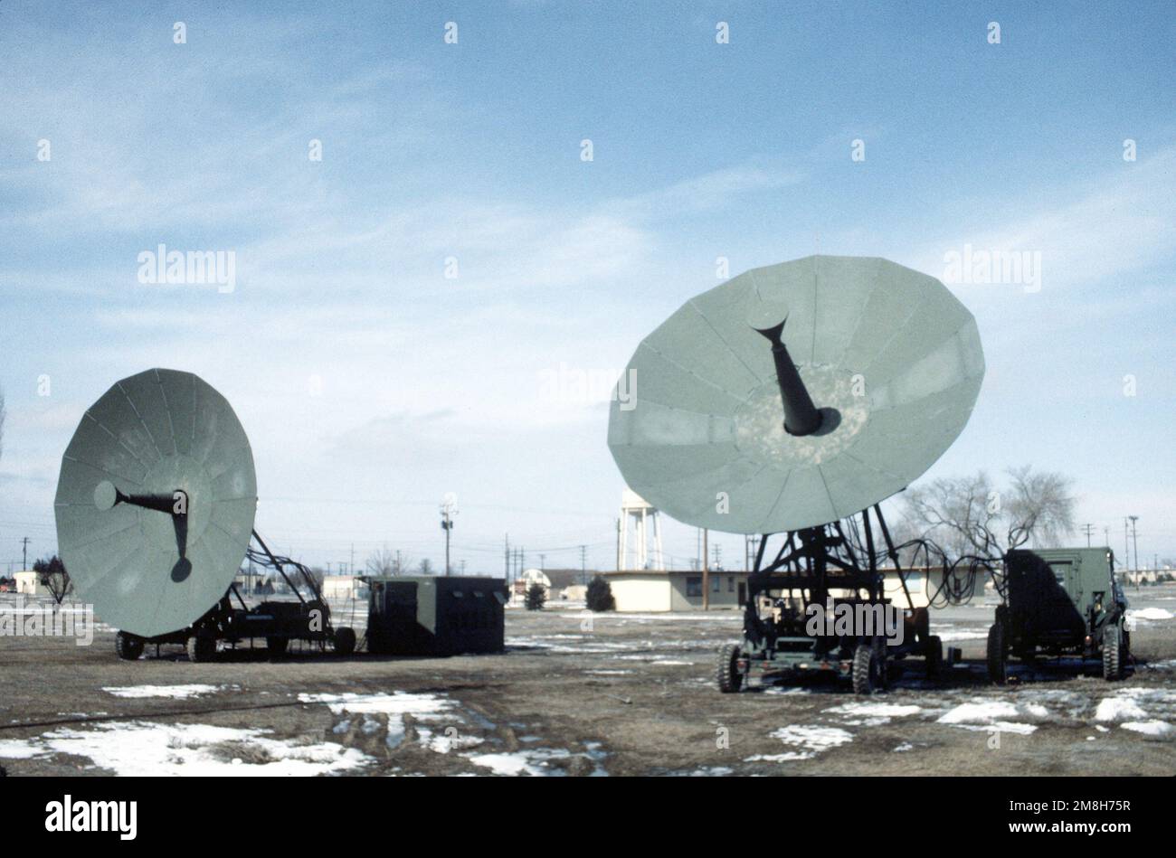 Two quick reaction satellite antennas on mobile stands are set up and ...