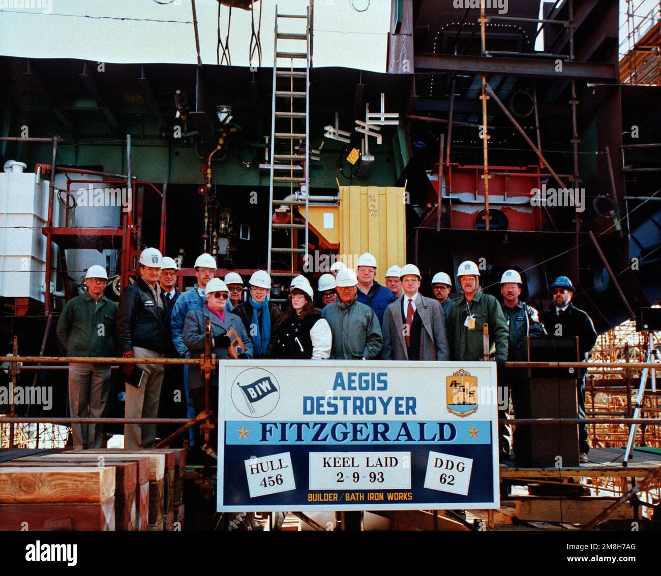 U.S. Navy representatives and officials of Bath Iron Works pose for a ...