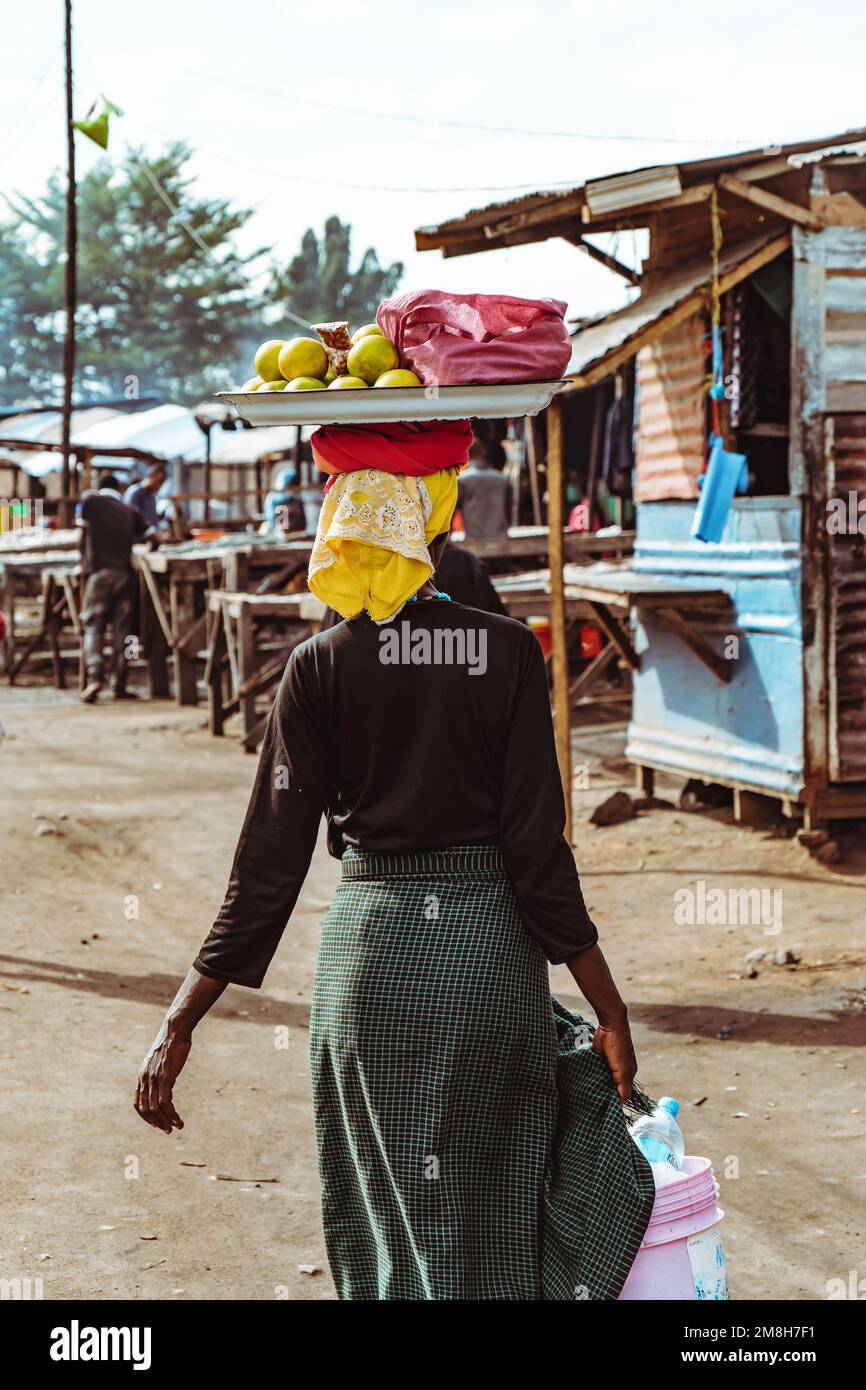 25.03.2022 - Mwanza, Tanzania - Local African women walking while ...