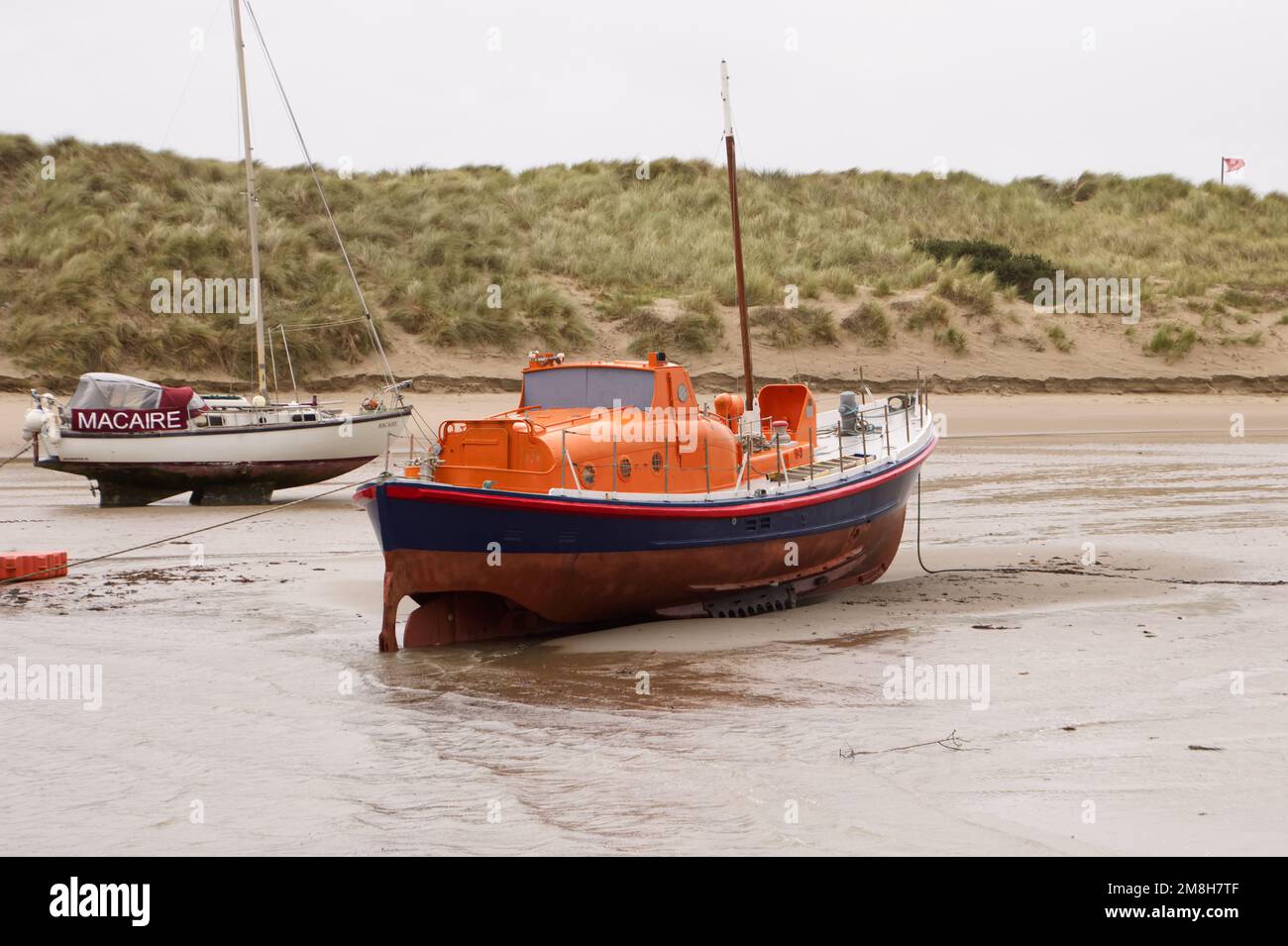 Old lifeboat in harbour at Barmouth, Wales, in low tide Stock Photo - Alamy