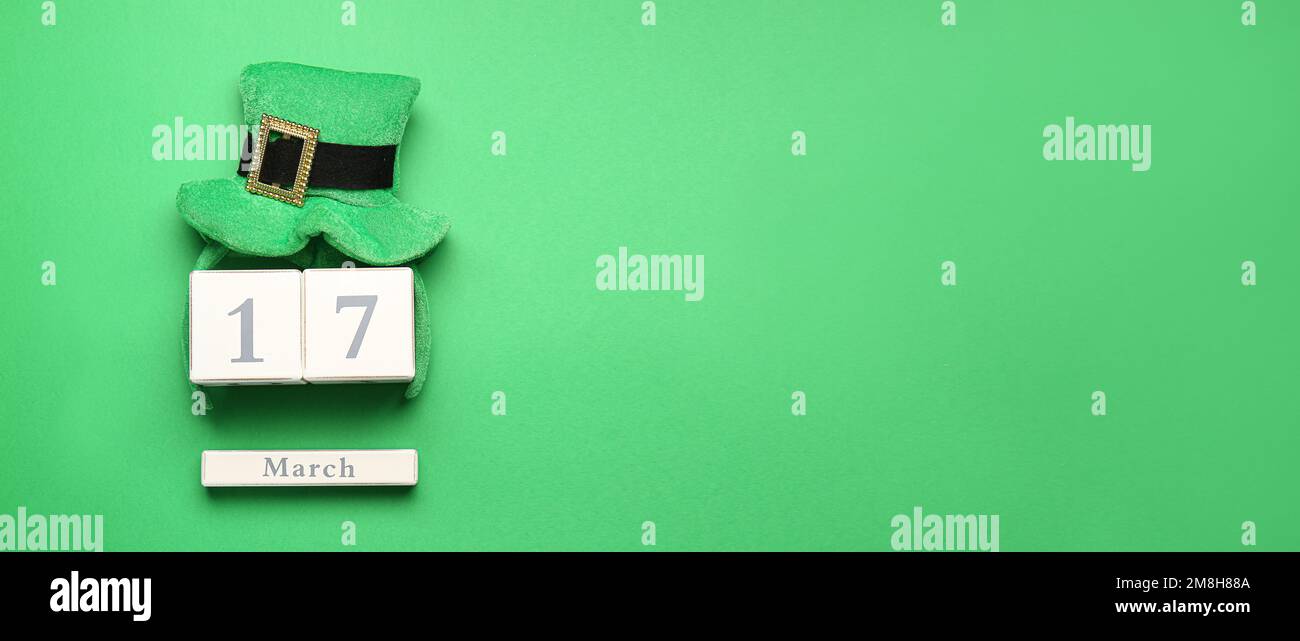 Leprechaun's hat and calendar with date of St. Patrick's Day on green ...